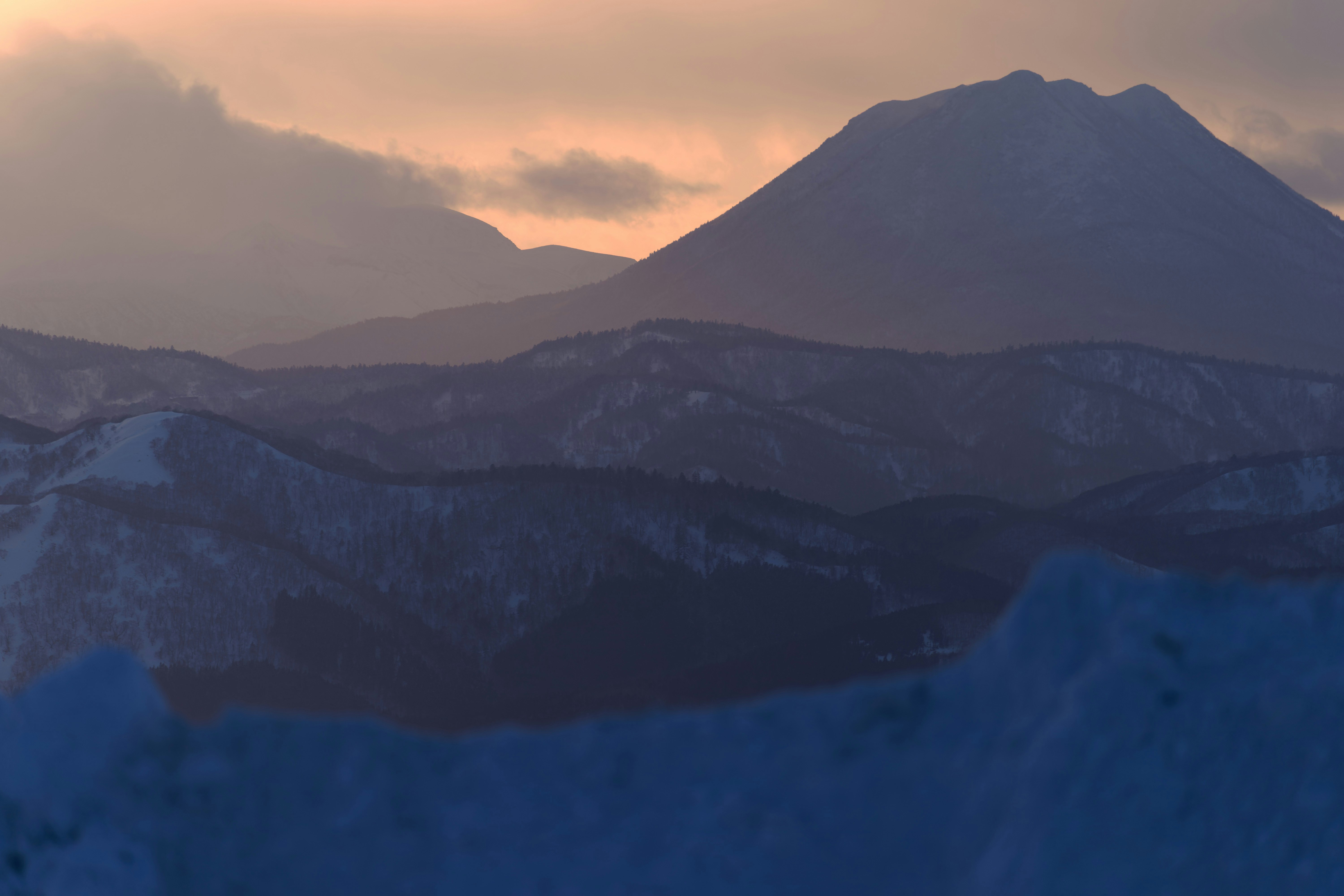 Distant Peak Above Blue Glacier Ridge at Dusk