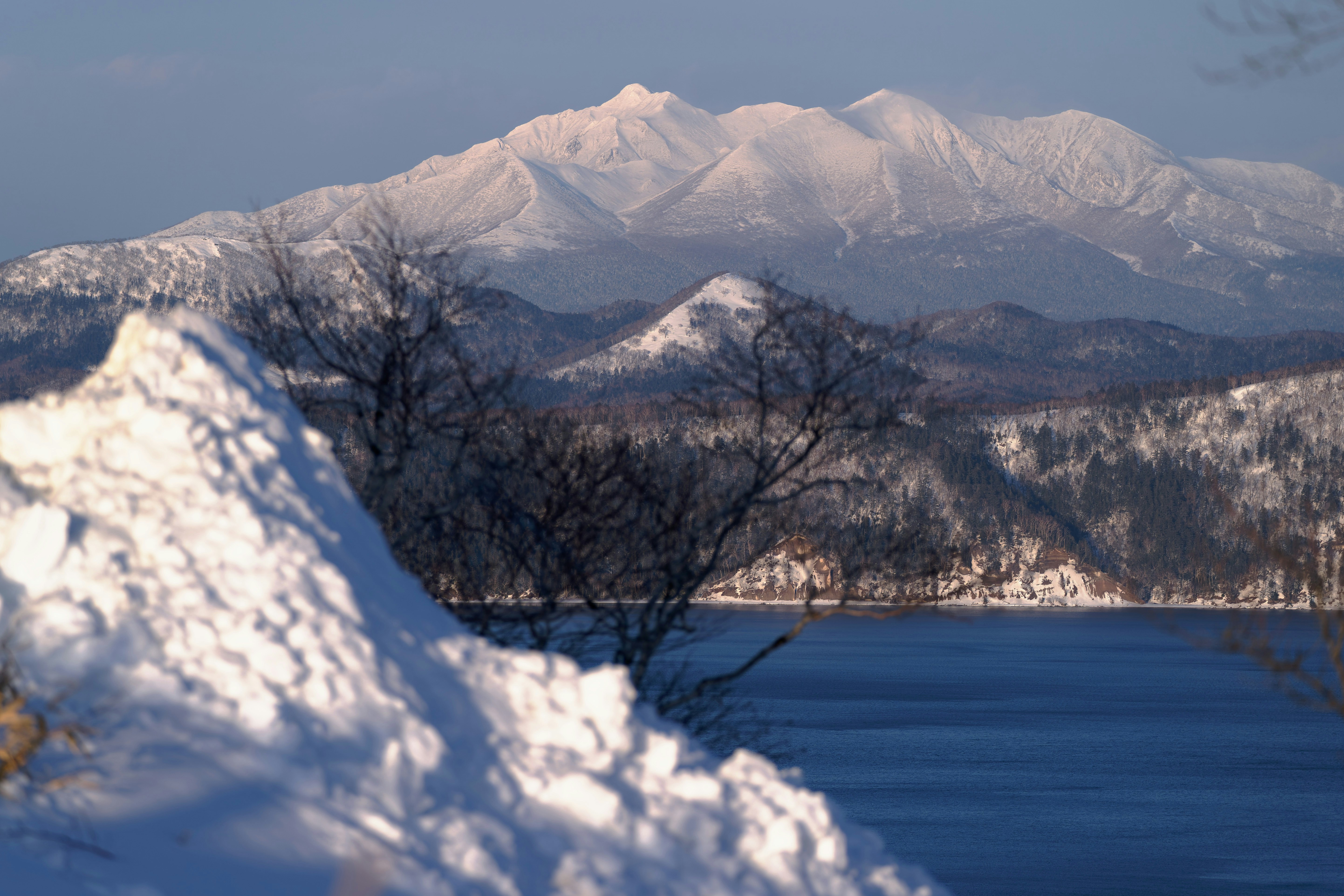 Snowbound Promontory Over a Glassy Fjord