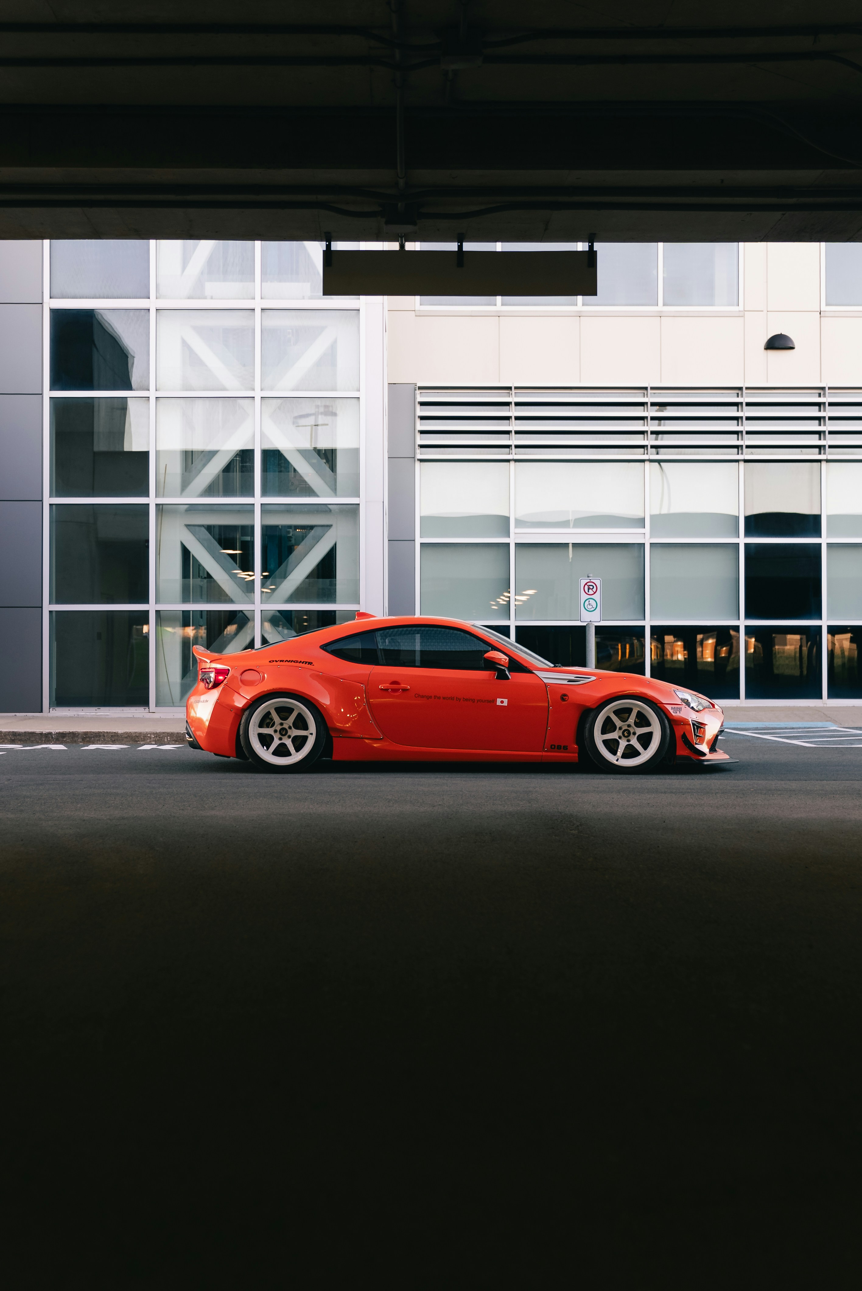 Red Coupe under an Urban Canopy
