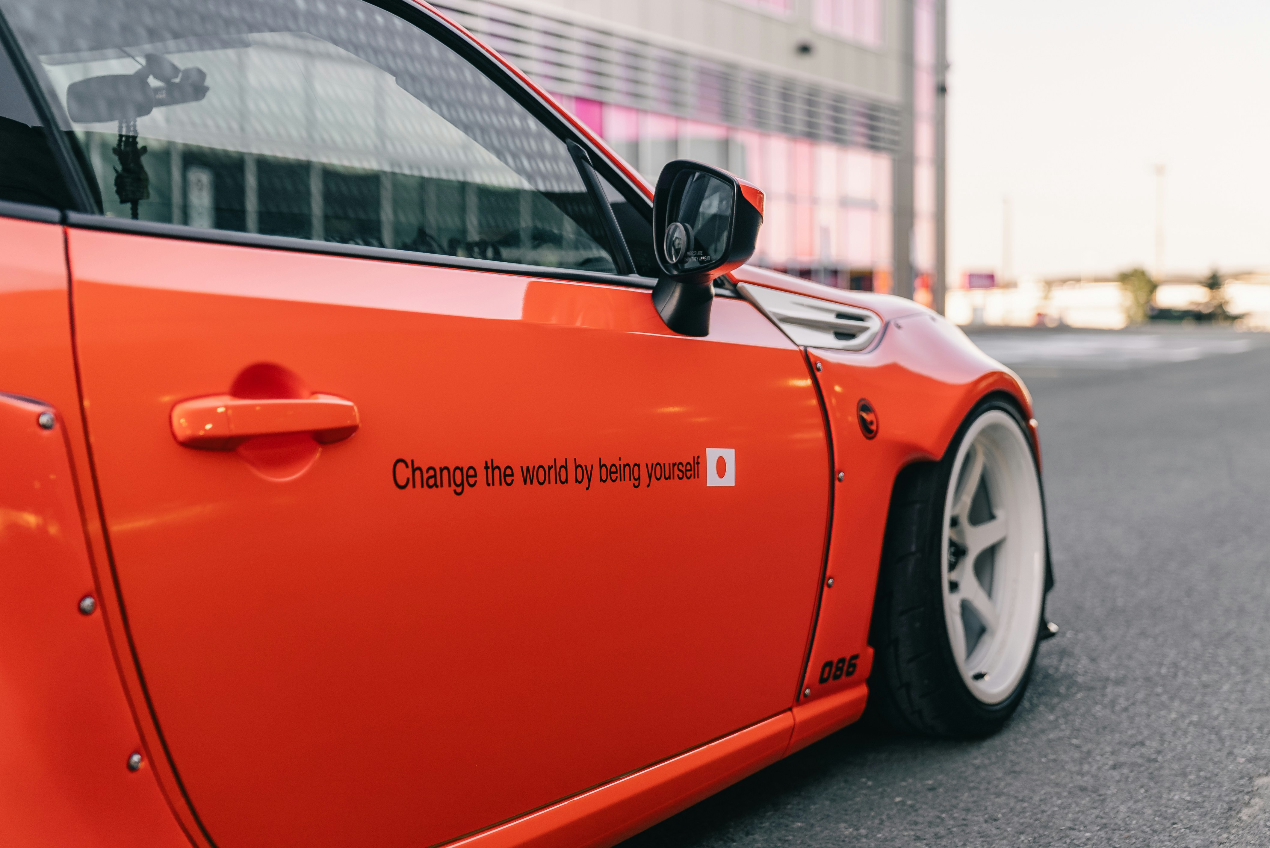 Orange GT silhouette: a close-up on the side of a tuned sports car
