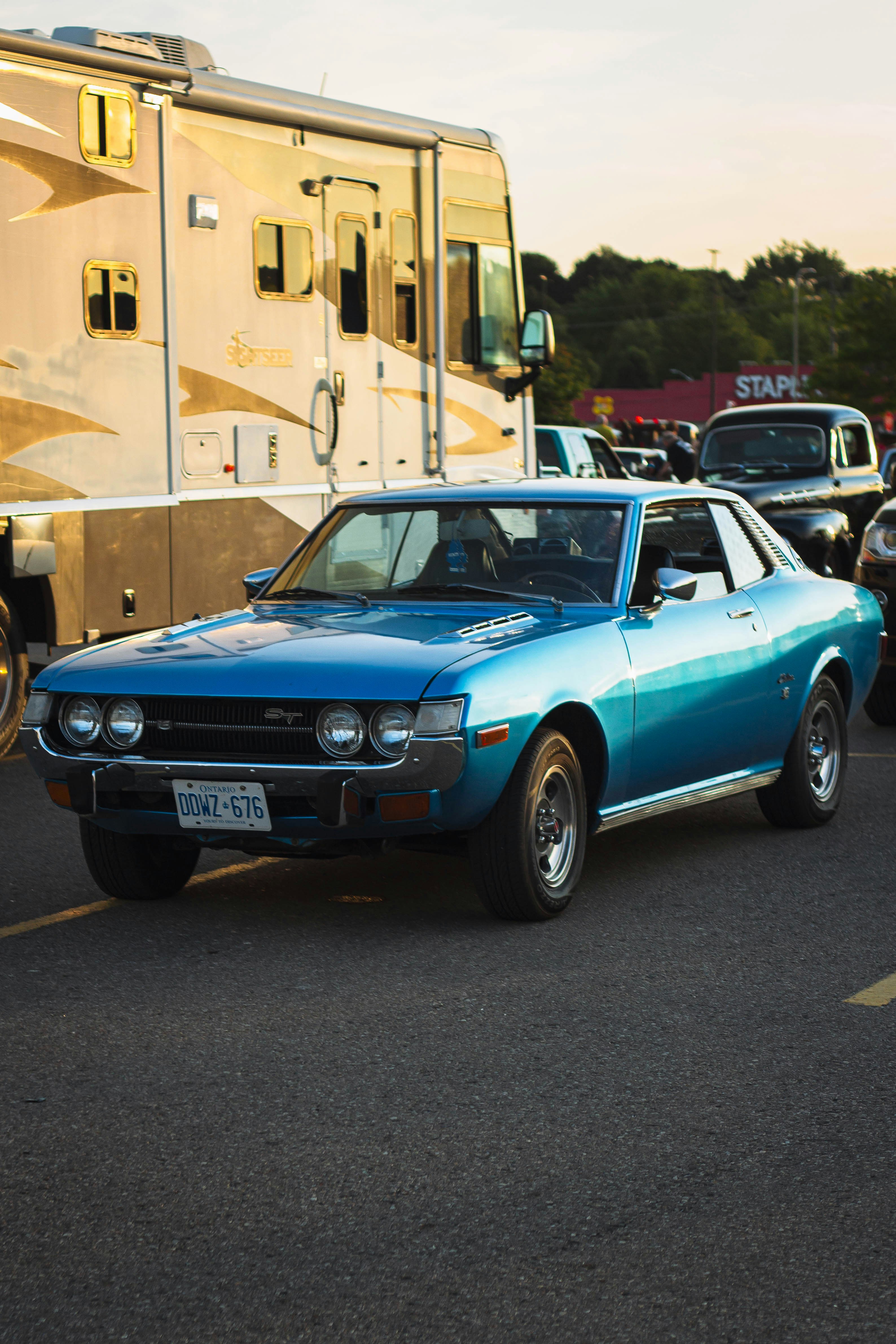 Blue Muscle Car at a Sunset Parking Lot