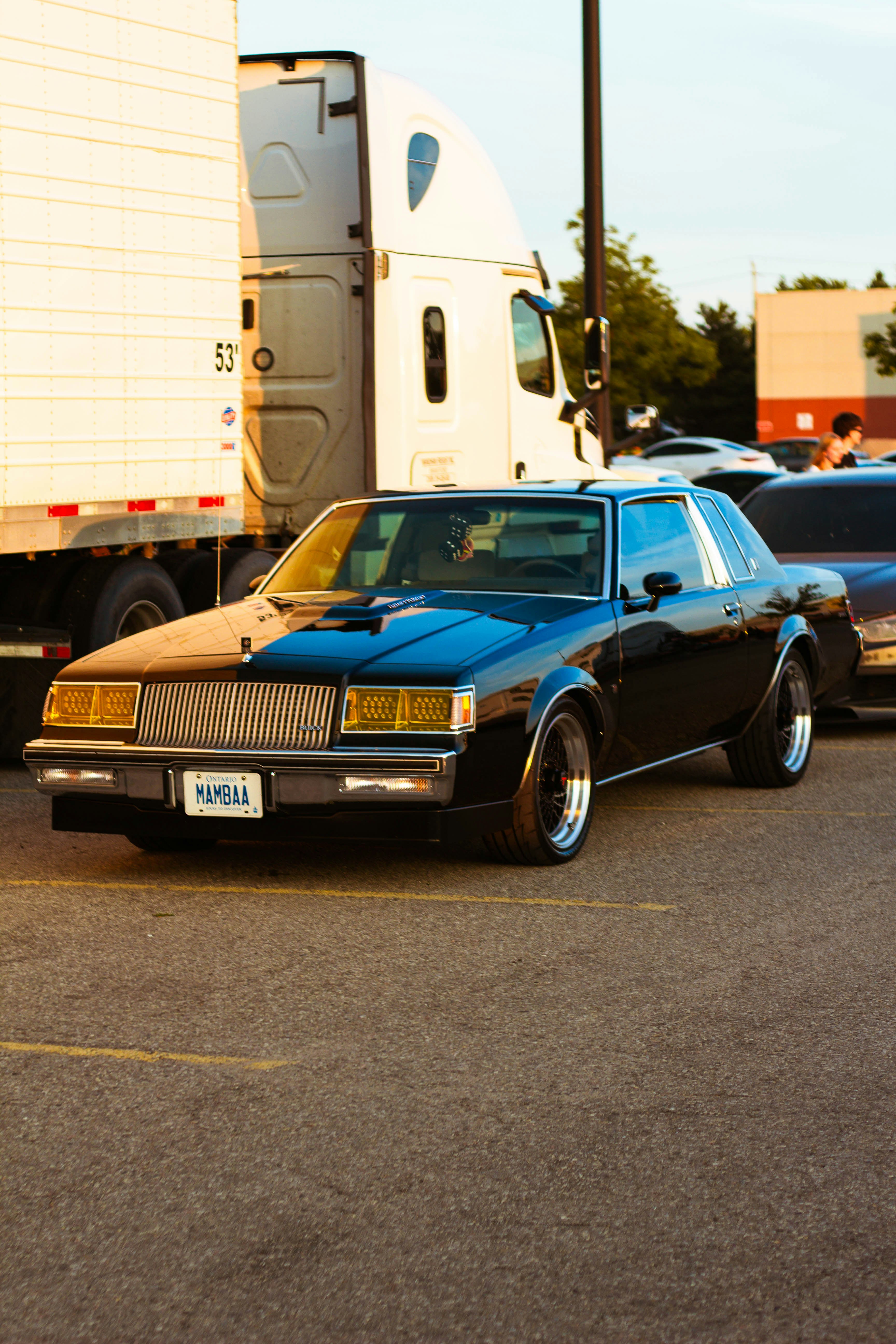 Midday Idle: A Blue Classic Beside the Truck