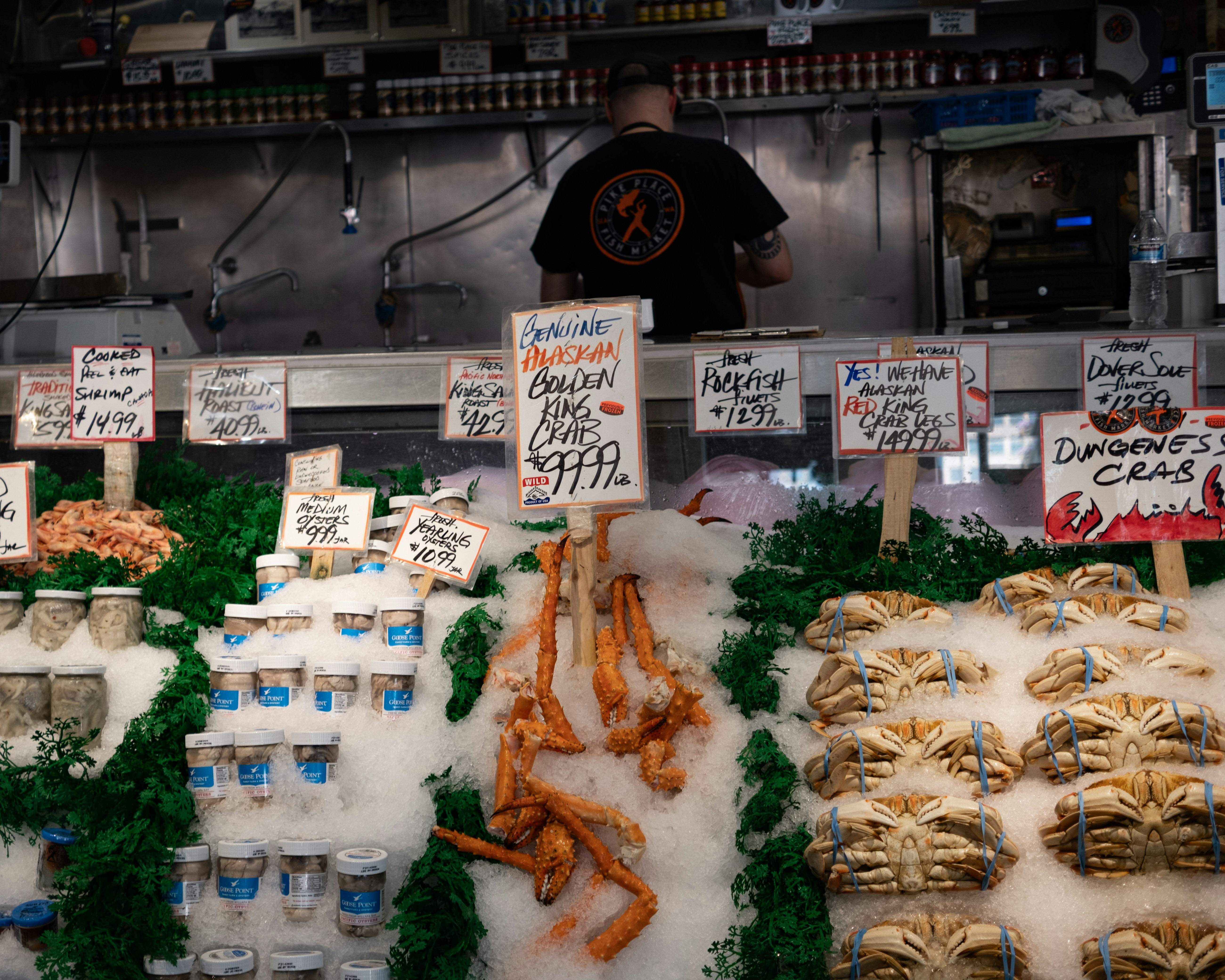 Market Seafood Stand: Fresh Crustaceans on Ice with a Busy Kitchen Behind