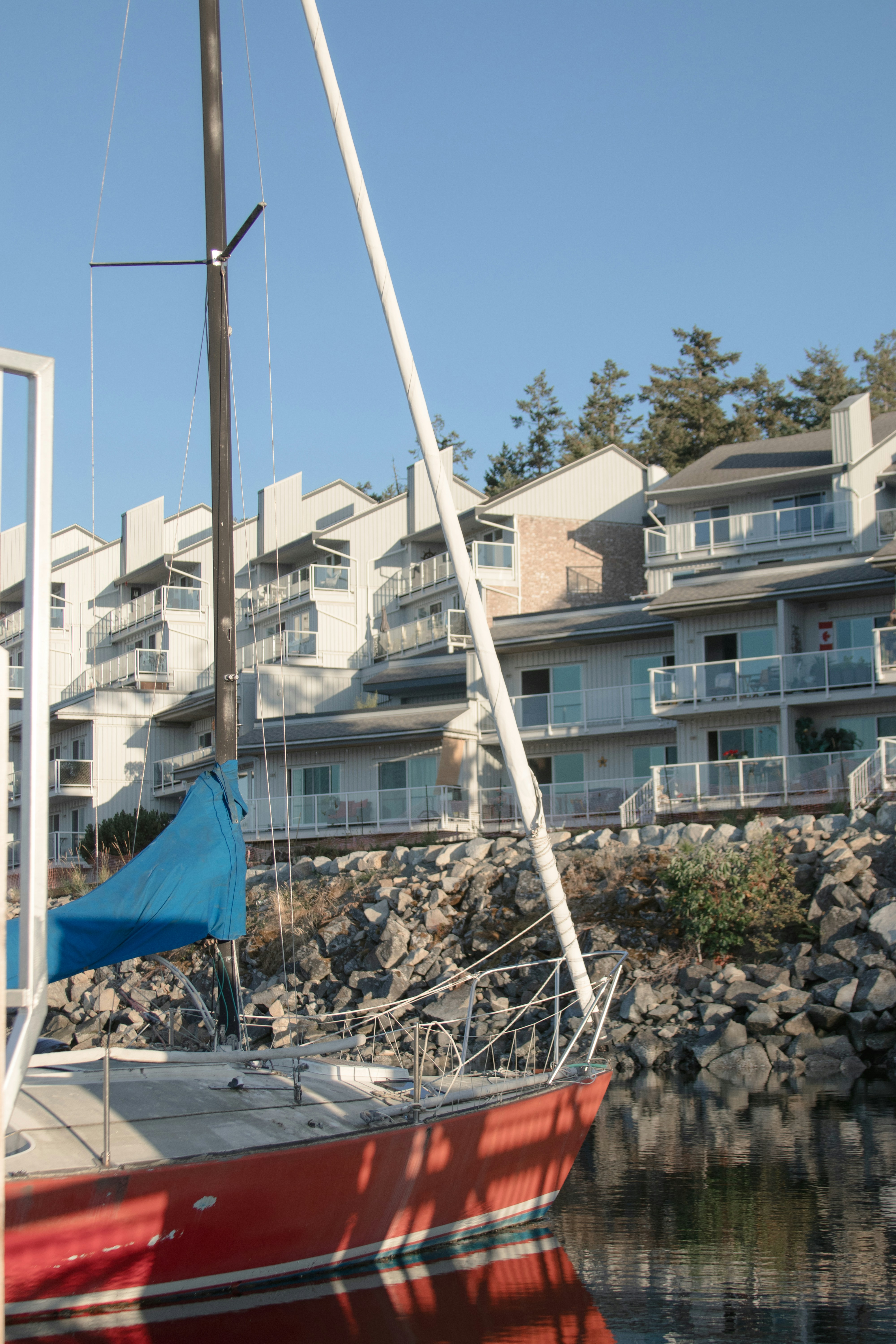 Sailboat at Rest Against a Waterfront Row of Modern Townhomes