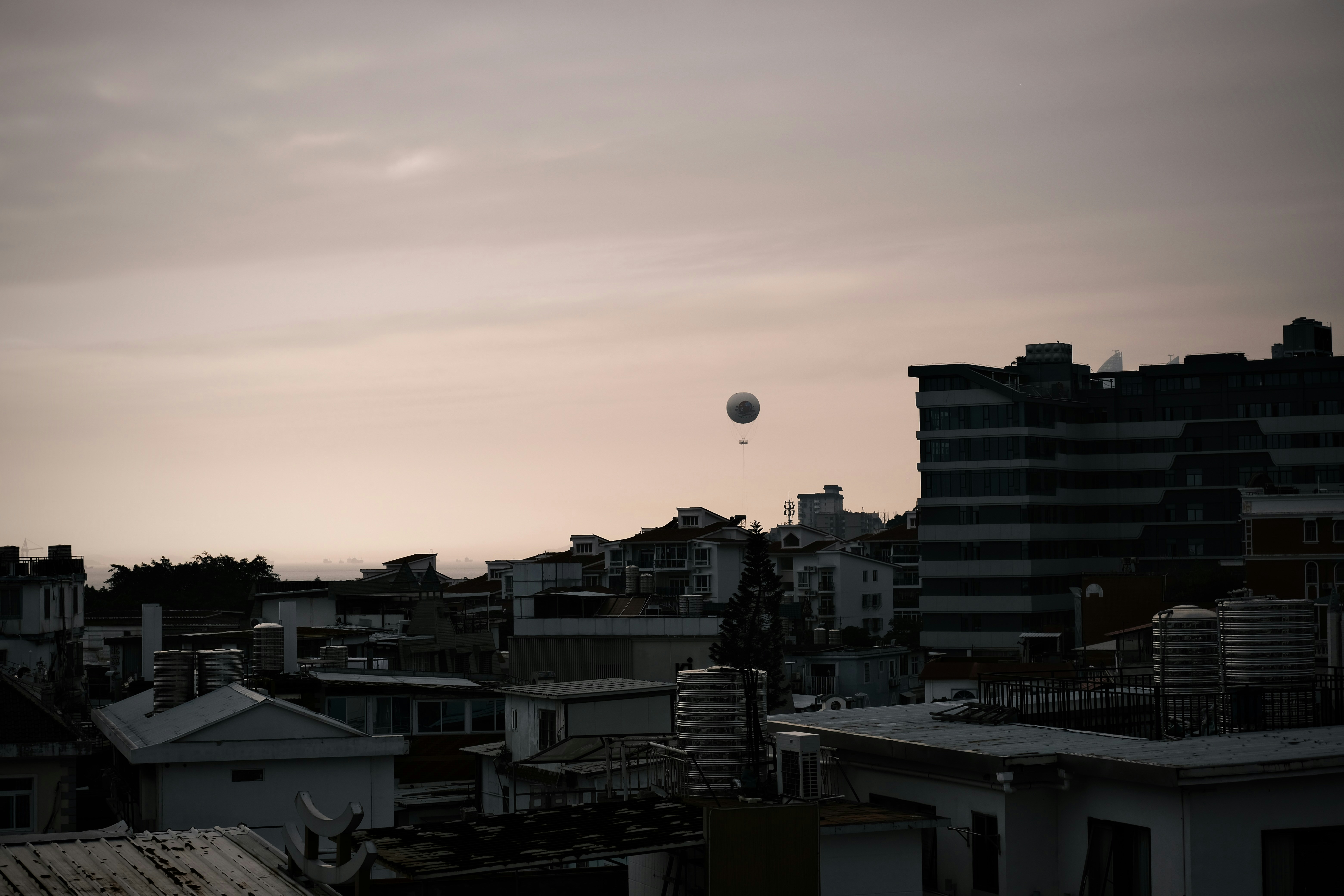 Balloon Over the Rooftops at Dusk