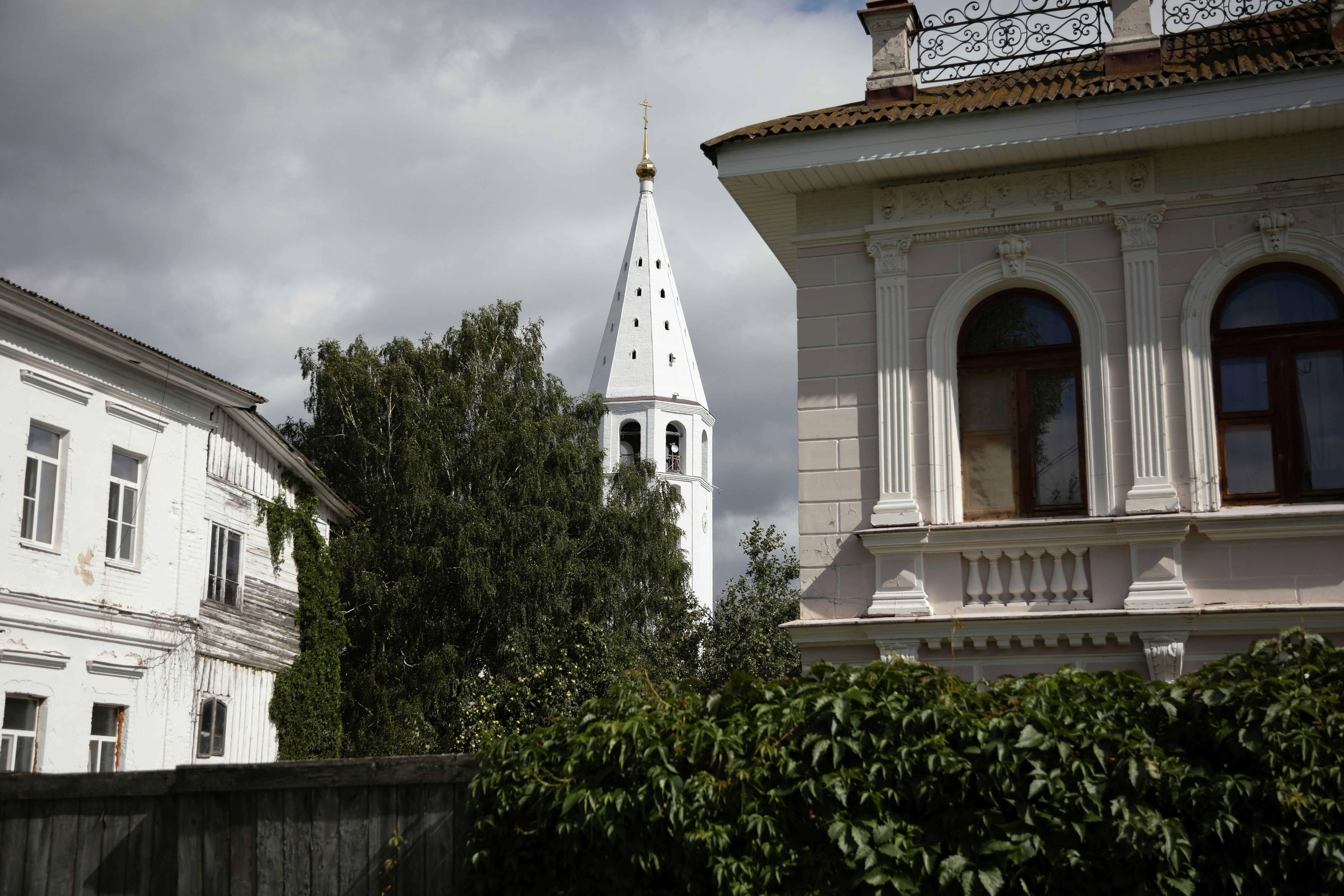 Church Spire Peeking Over a Garden Wall