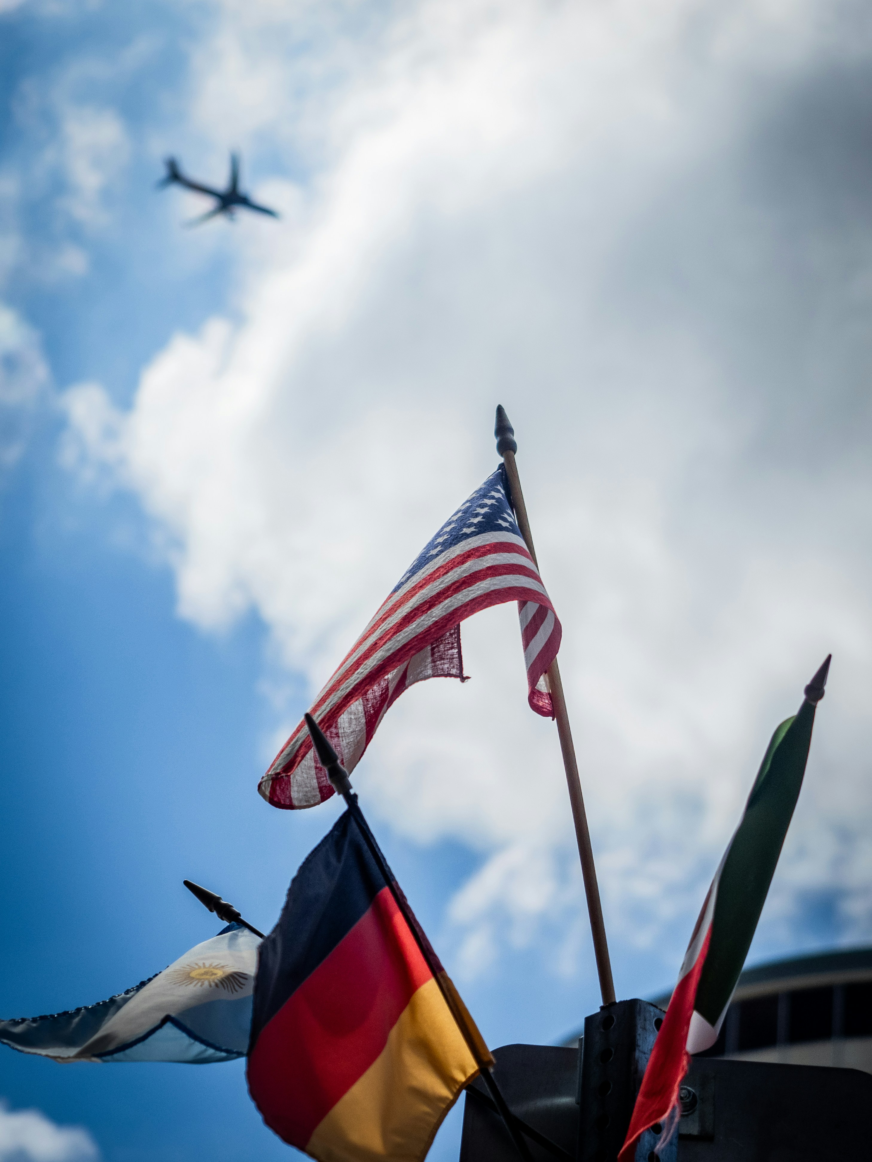 Flags in the wind under a passing jet