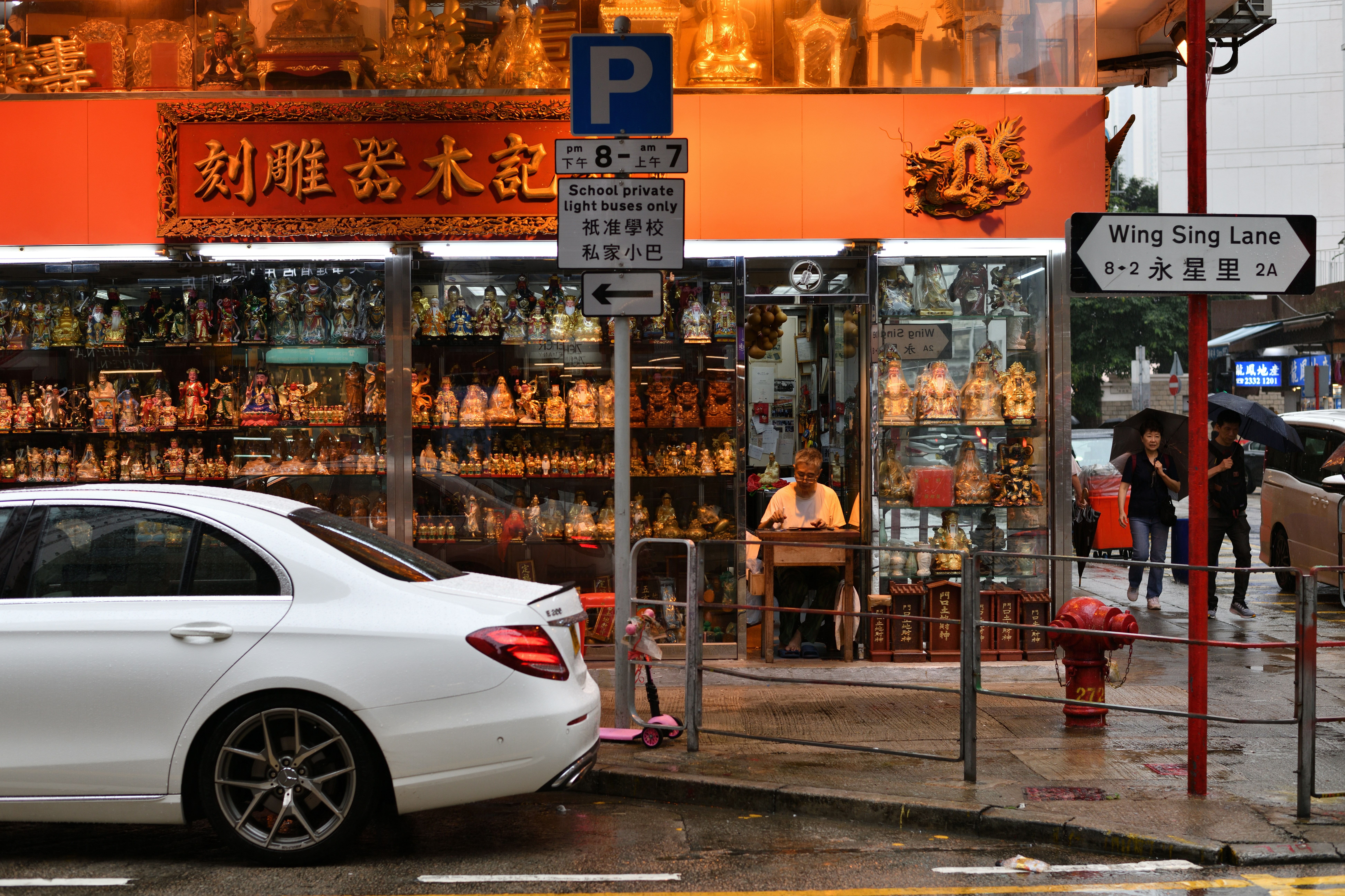 Streetfront Shrine: A Quiet Pause in a Bustling Hong Kong Market