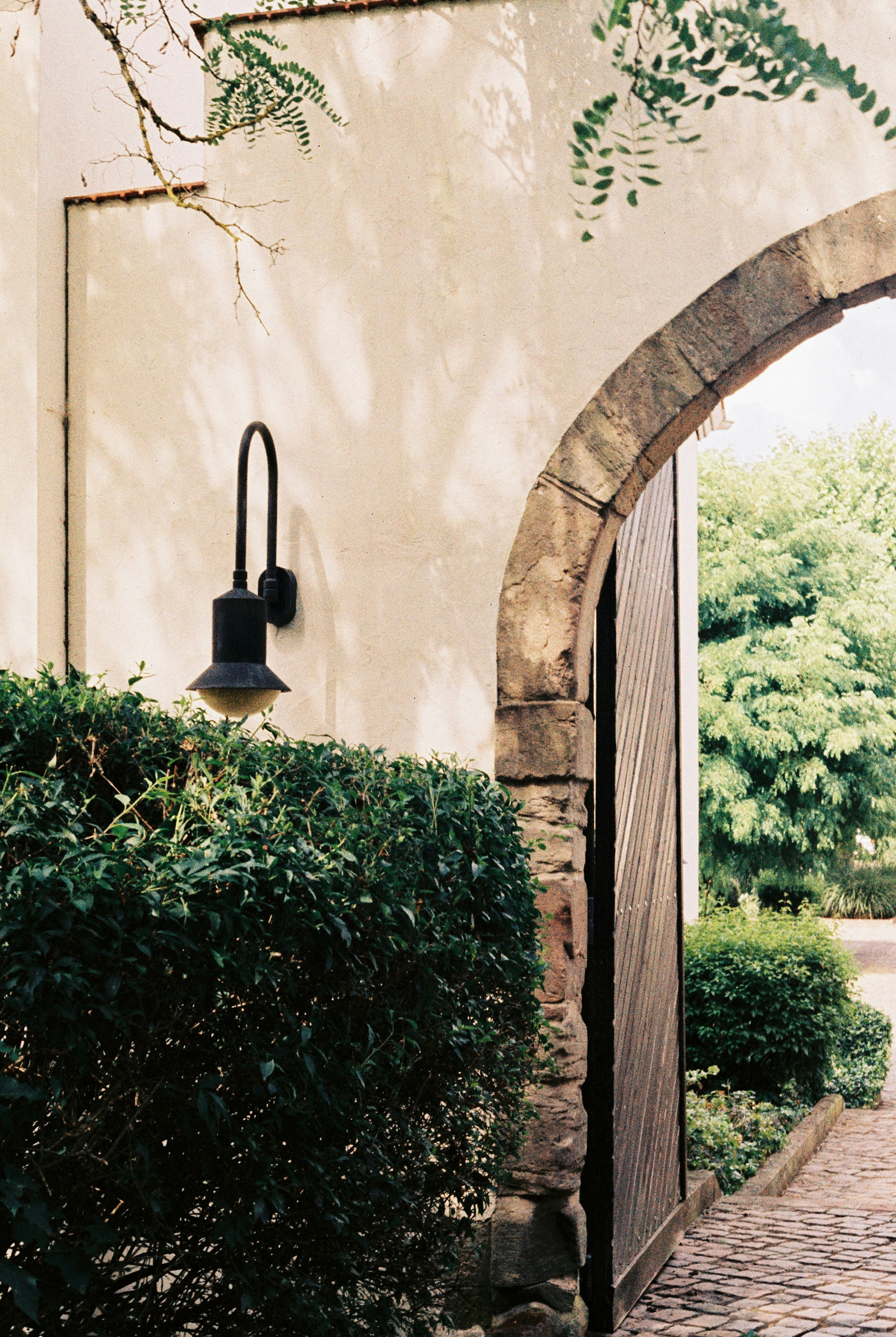 Stone Archway Framed by a Lantern and Garden Path