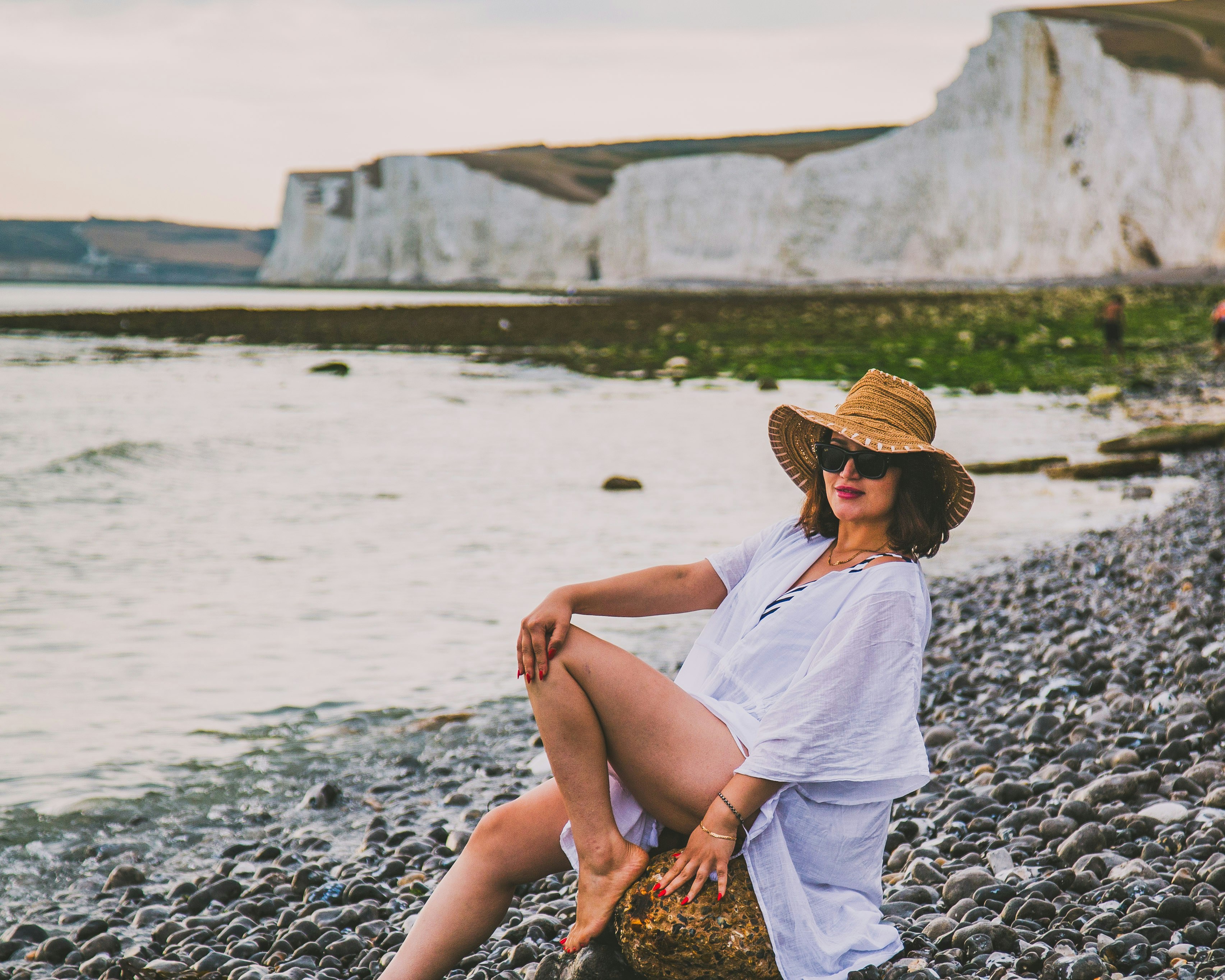 Sunlit Recline: A Seaside Moment in White Linen
