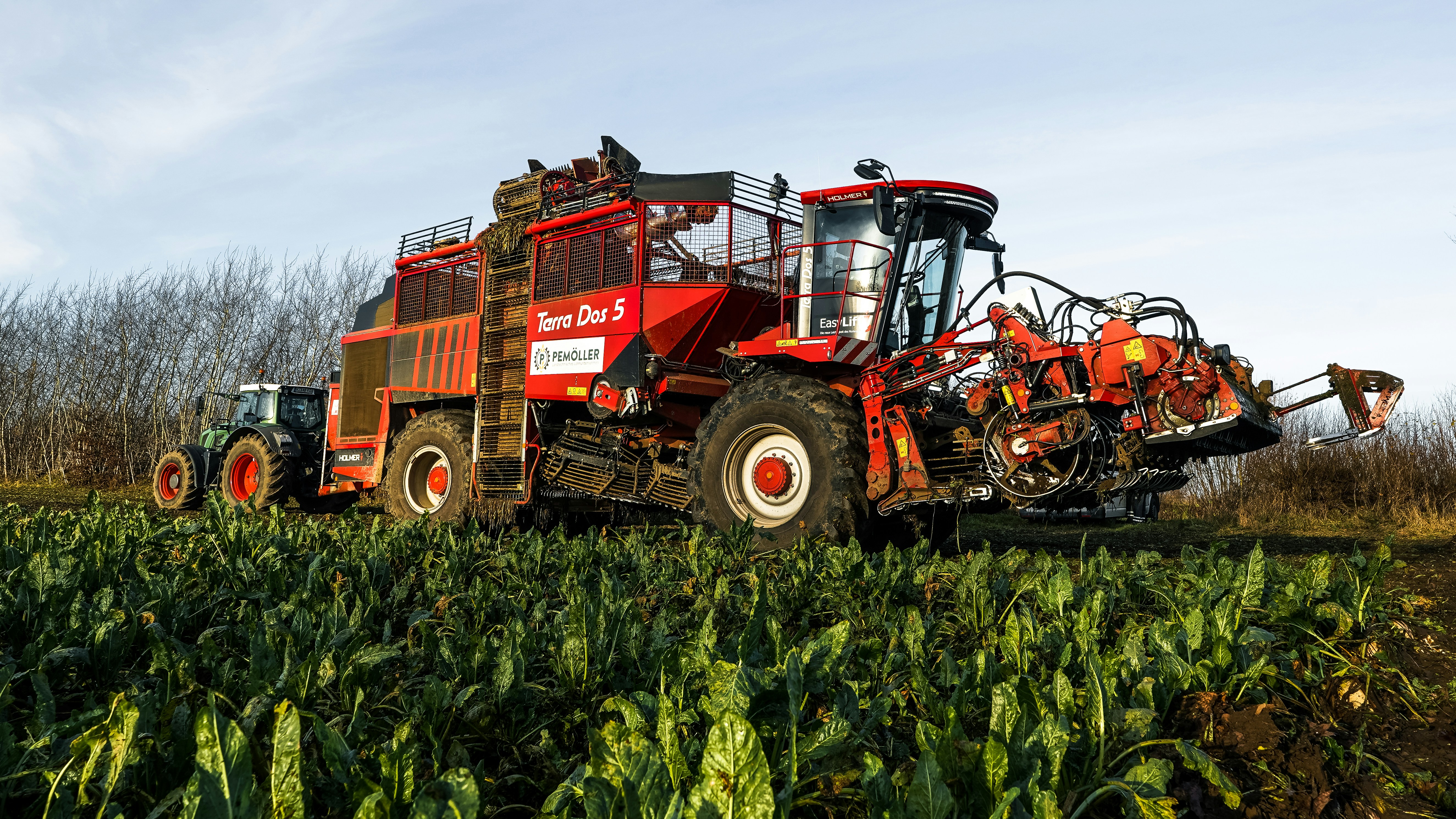 Harvest Machinery Rumble: A Red Titan Stands Over Seeded Field