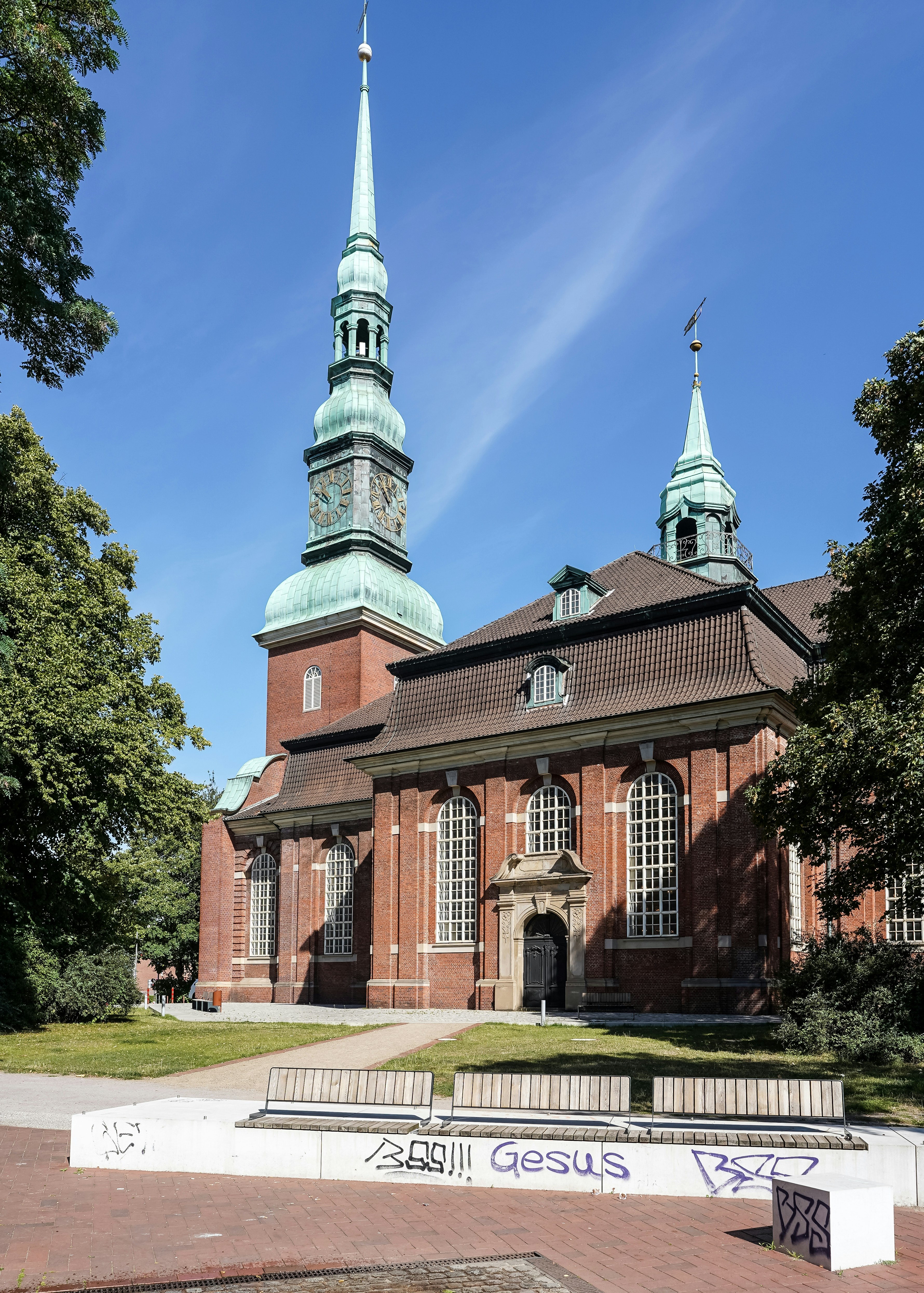 Brick Church with Twin Steeples under a Clear Blue Sky