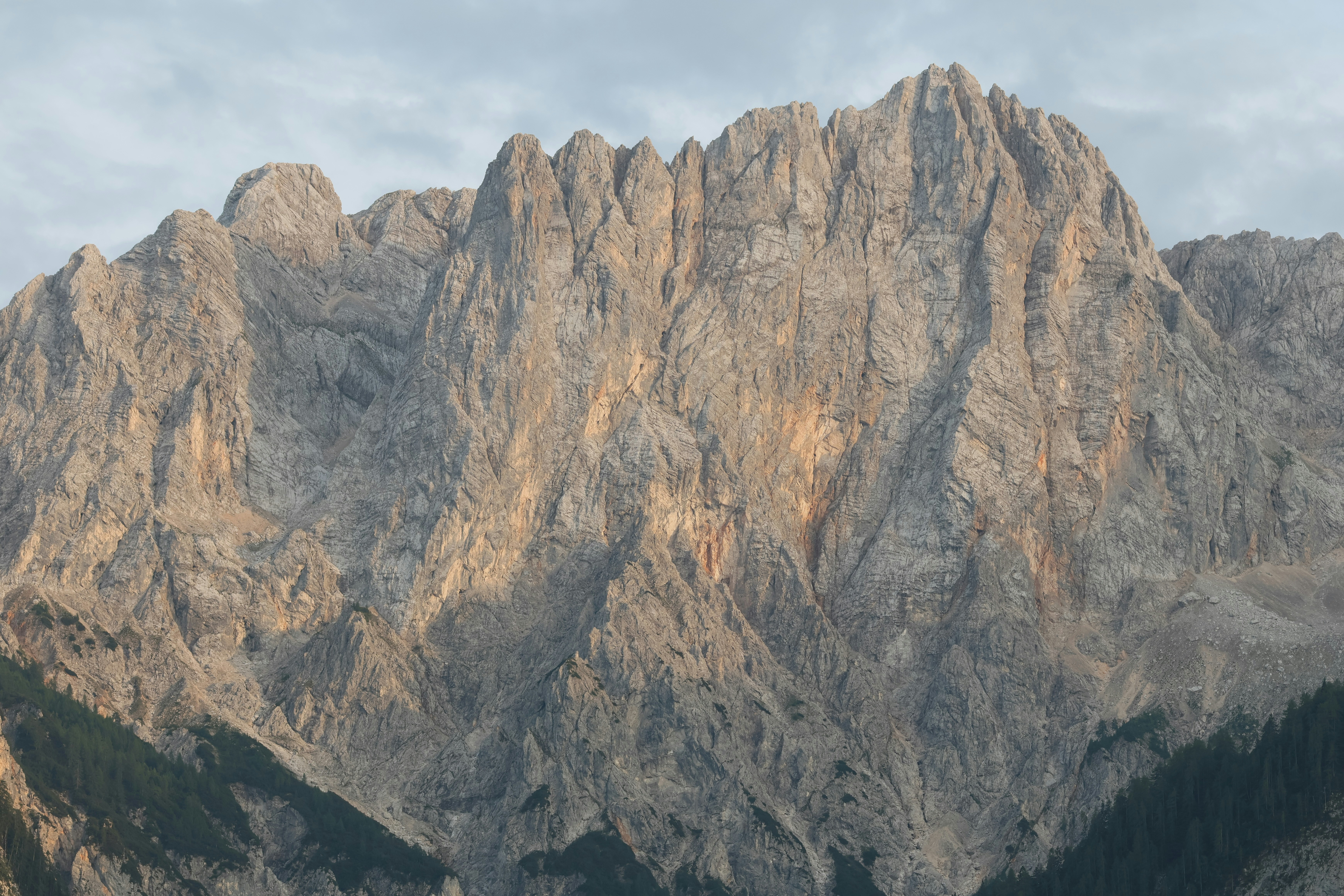 Sunlit Crest: A Rocky Alpine Facade