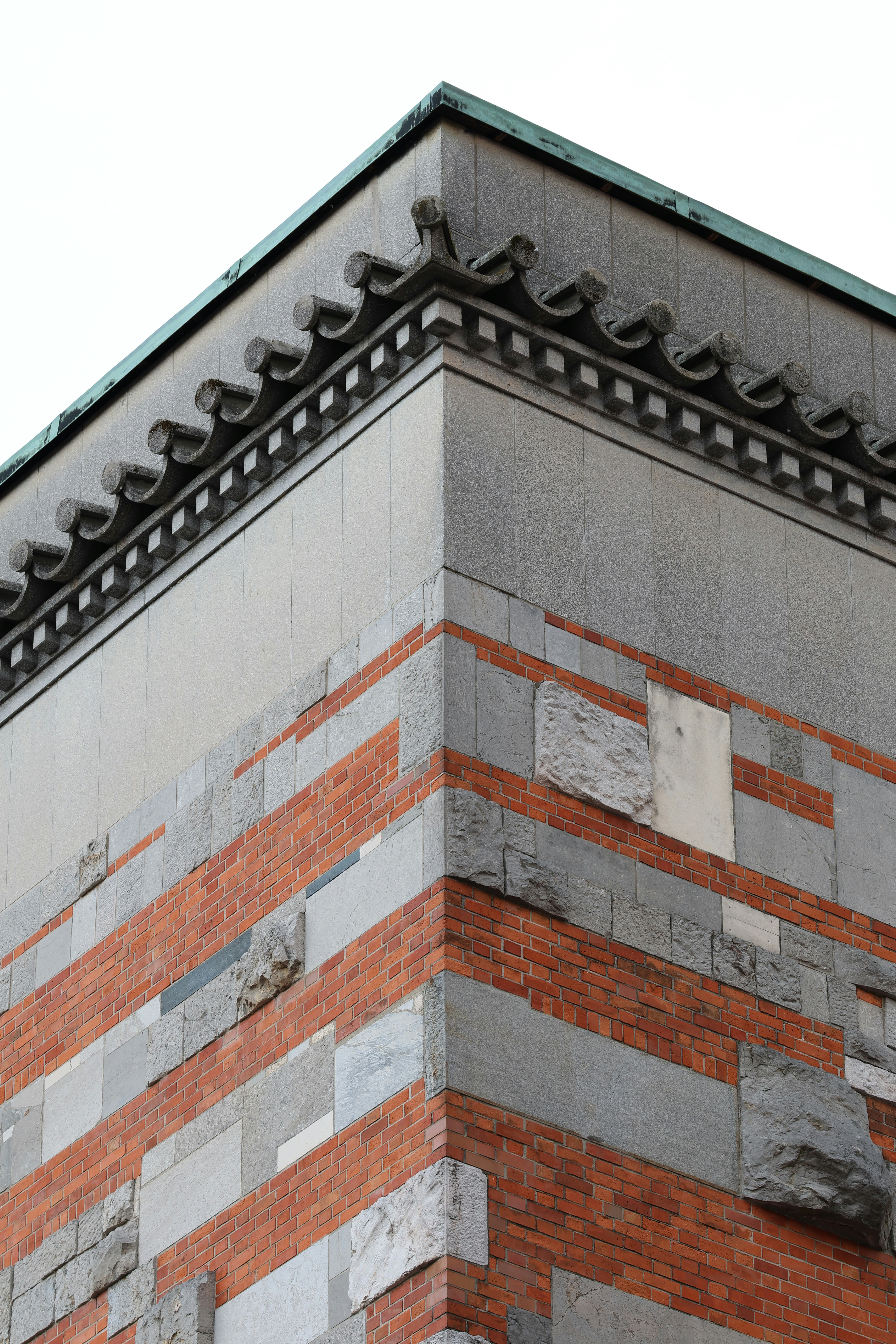 Cornerstone of Brick and Stone: A Geometric Facade in Red and Gray
