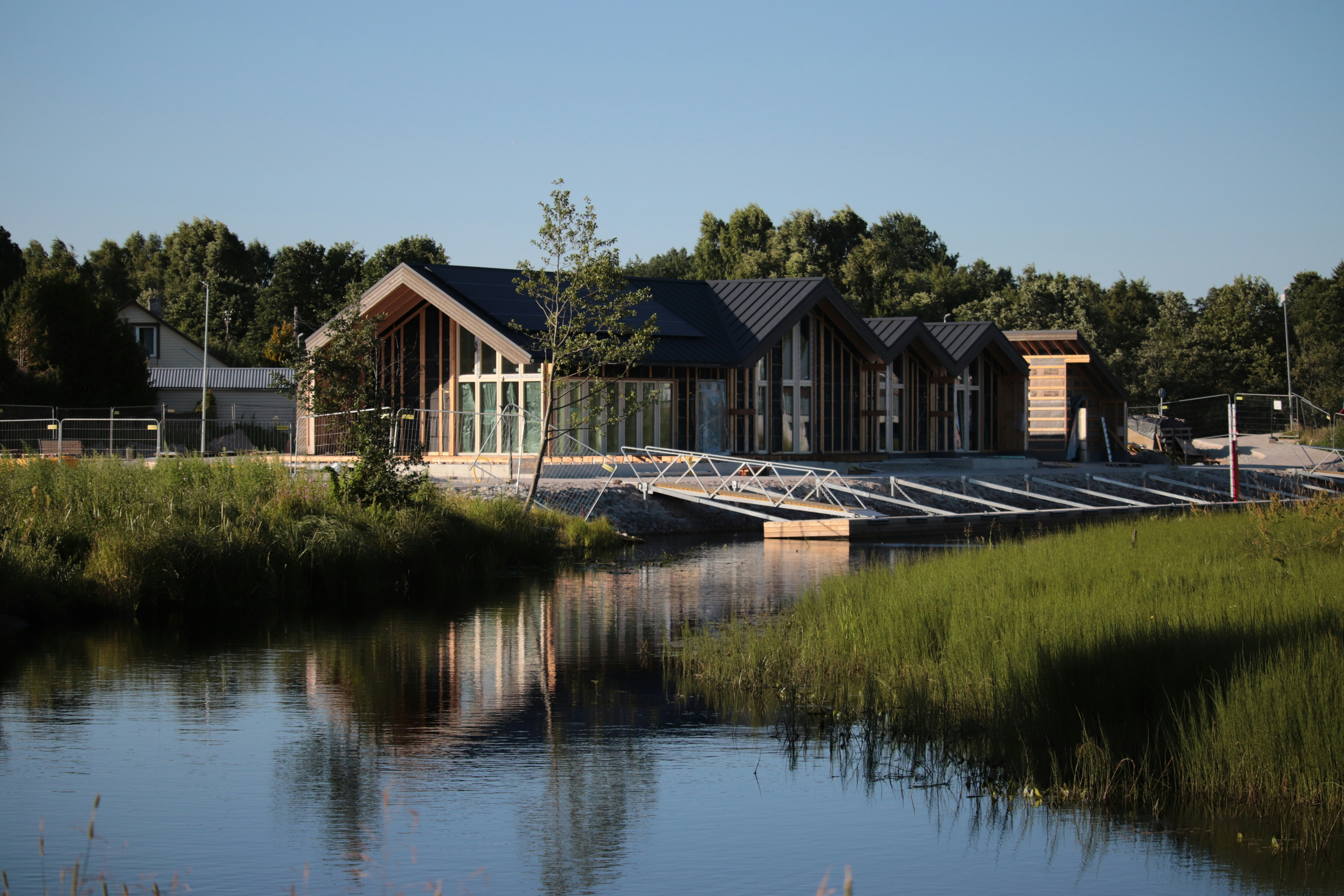 Glass-walled pavilion by a tranquil marsh