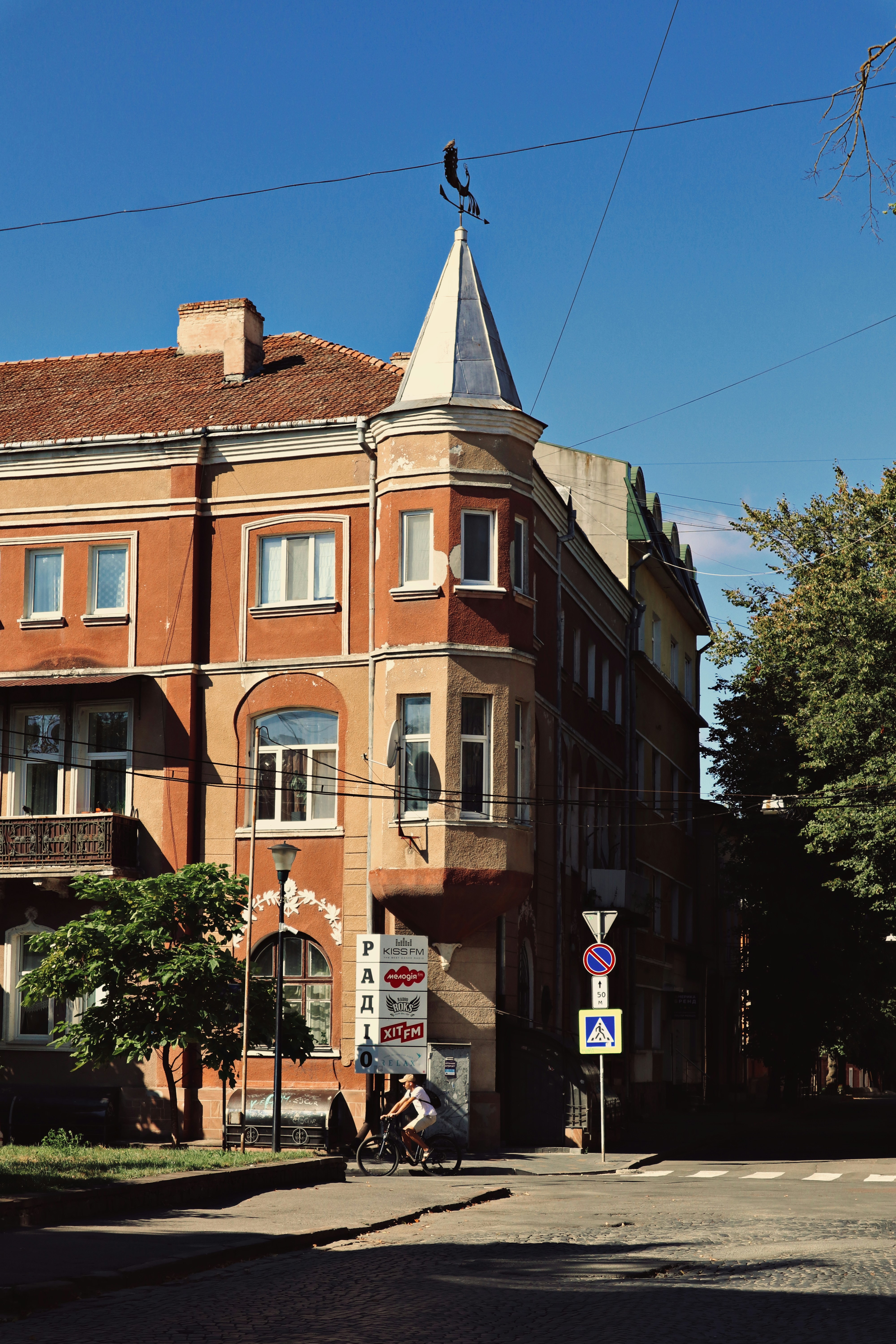 Corner Turret and Red Brick Facade: A Quiet Street Slice