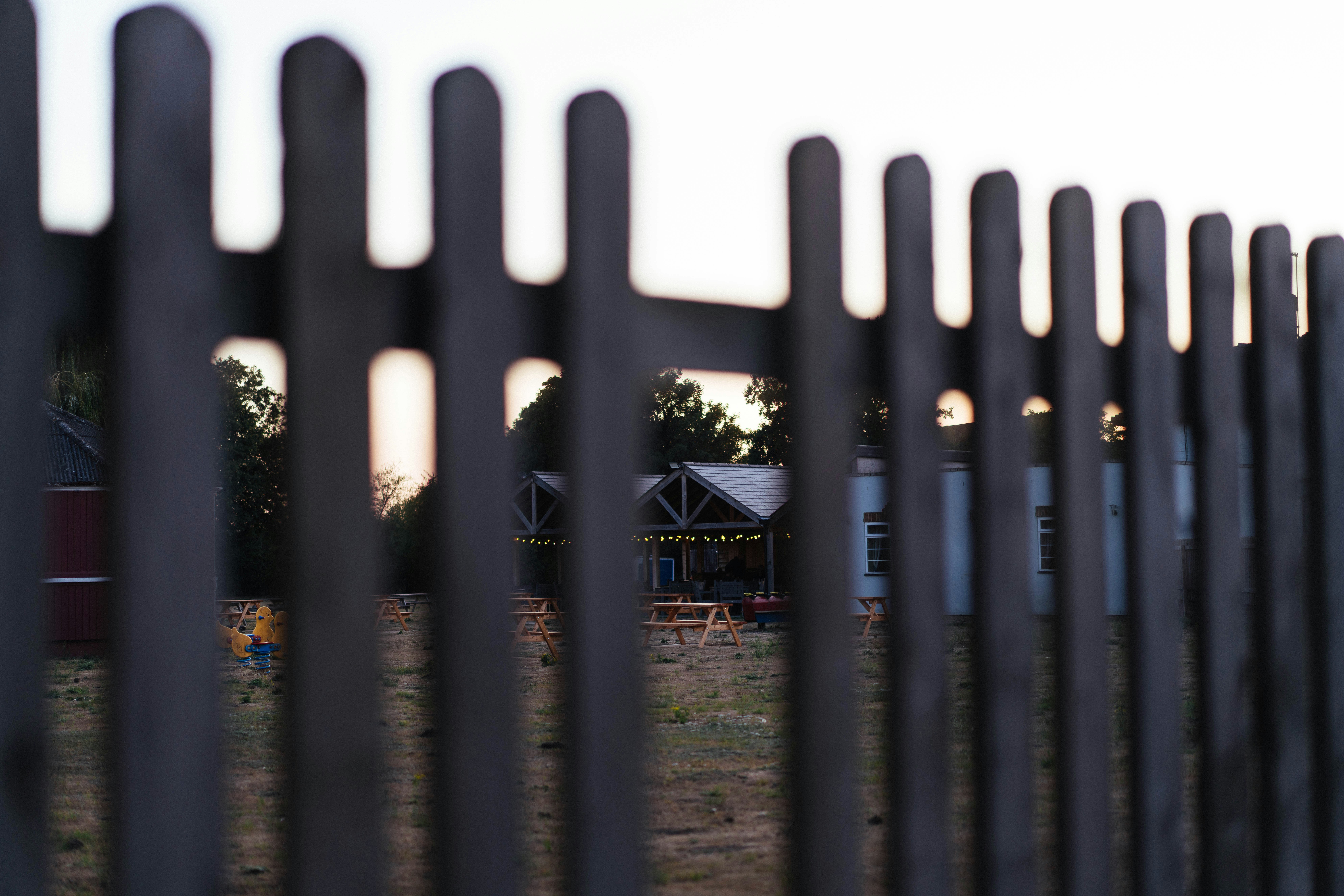 Hidden Playground: Fence Framing the Quiet Park
