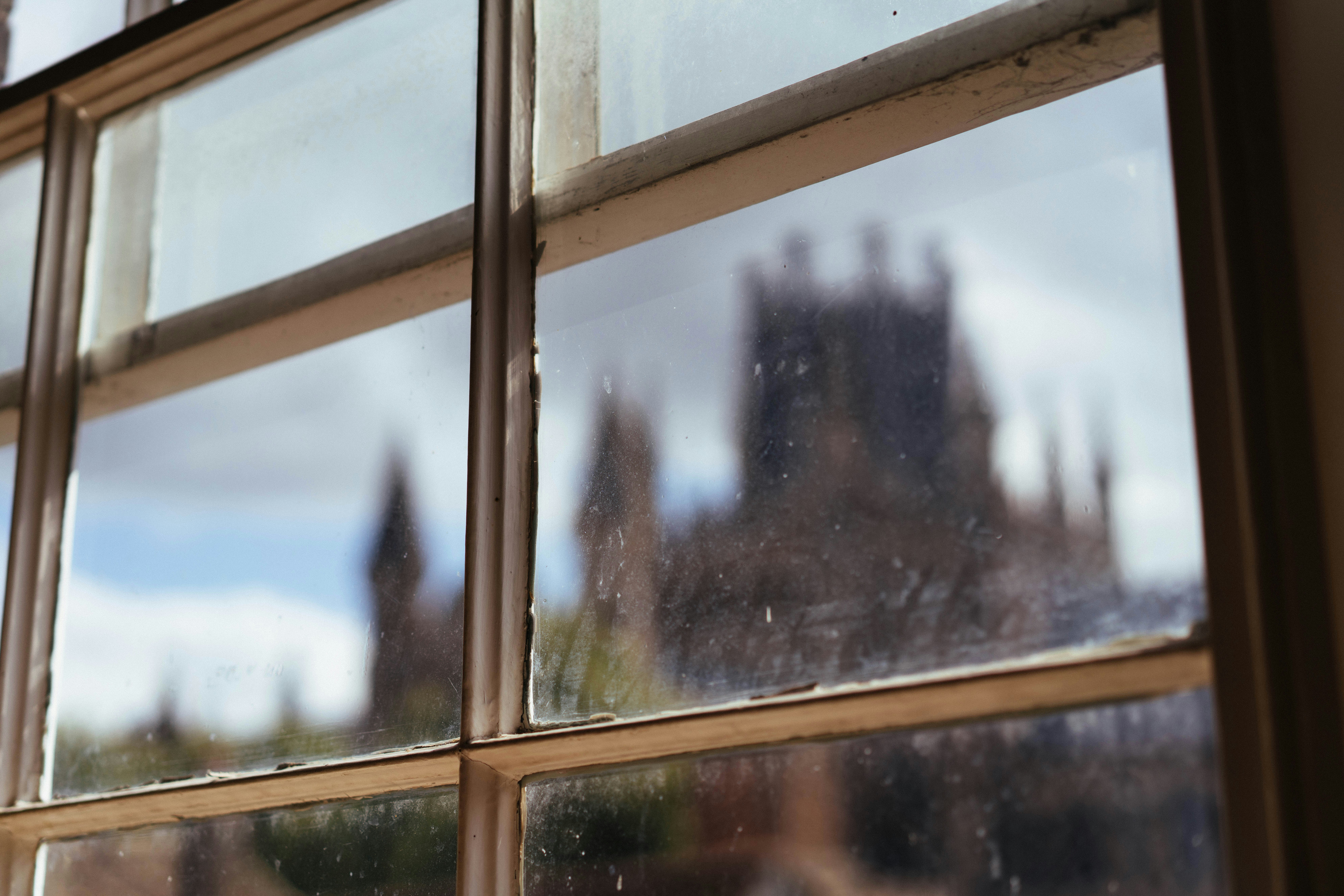 Through the Glass: A Cathedral's Silhouette Beyond a Glazed Frame