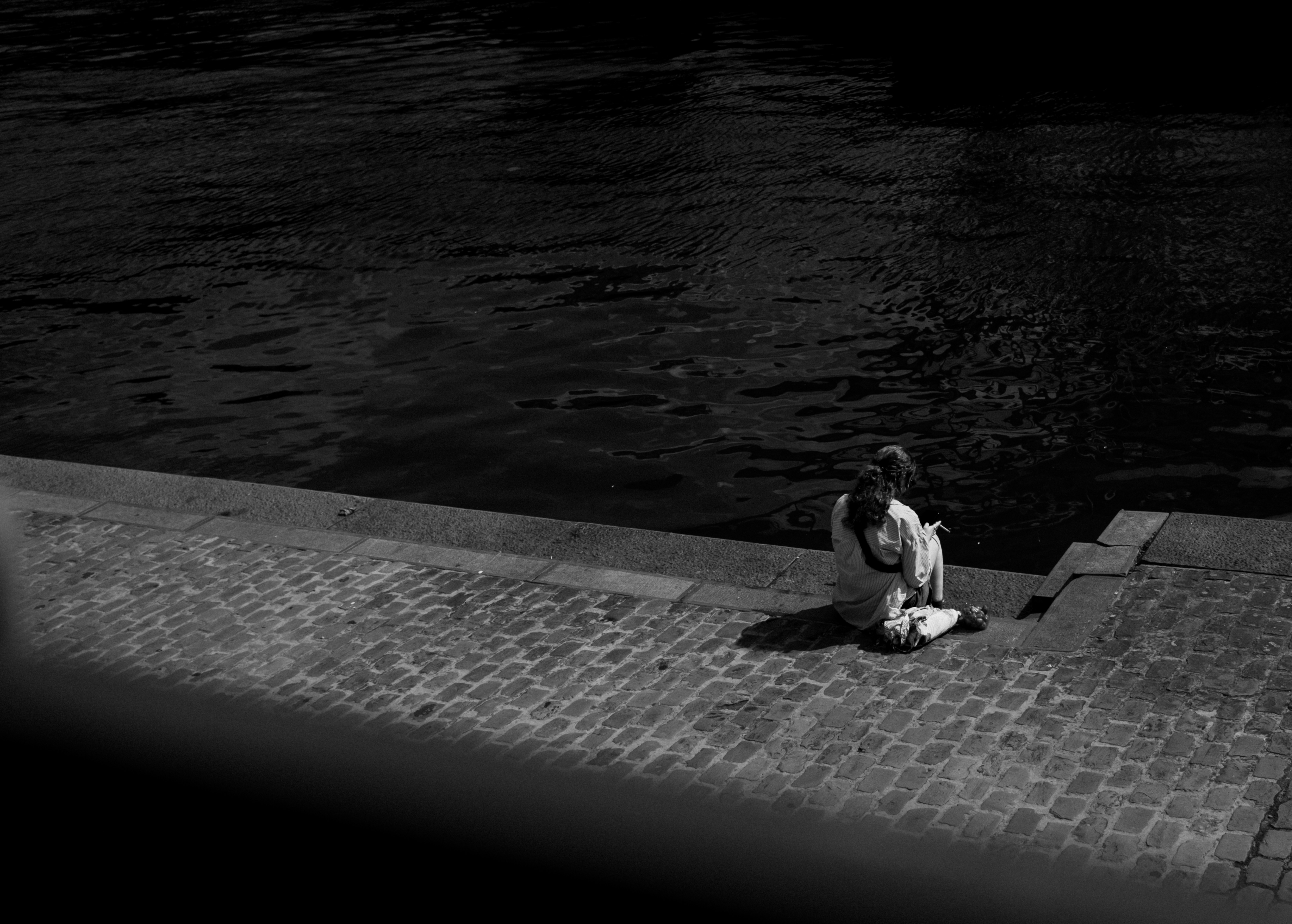 Solitary Moment by the Canal: A Quiet Echo on Cobblestones