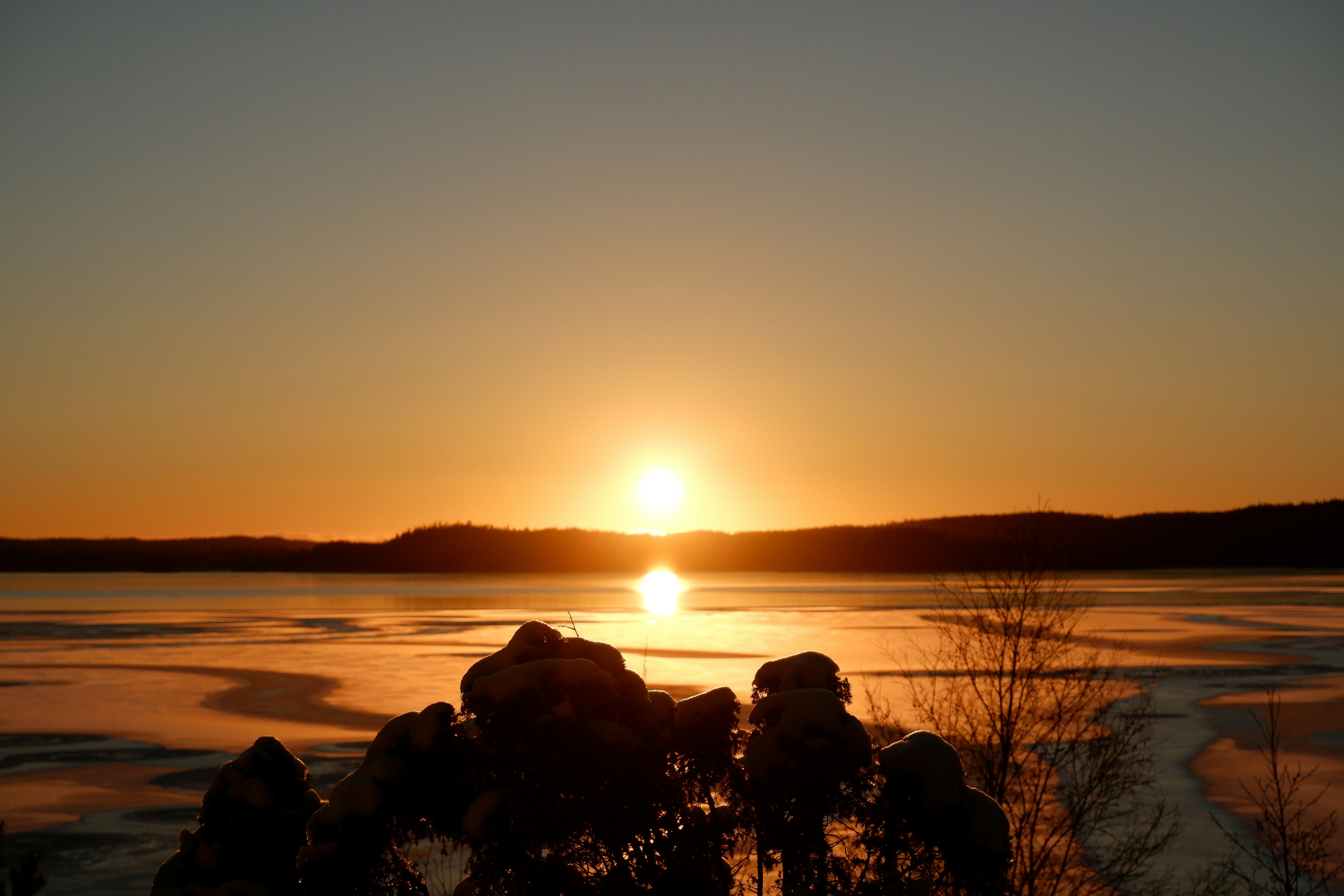Sunlit Horizon over a Quiet Ice-Scape