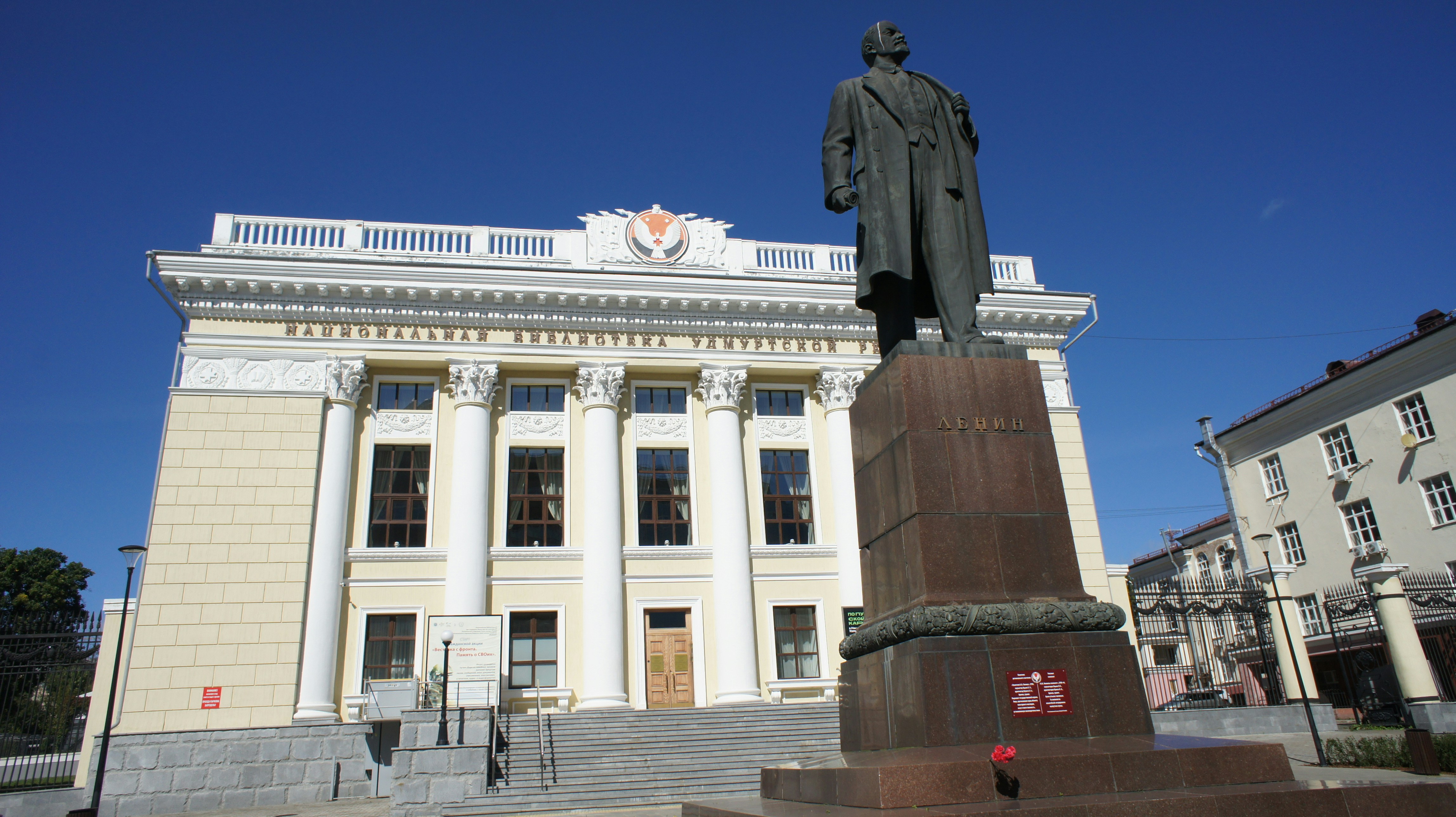 Statue Overlook: A Civic Hall Framed by a Prominent Columned Facade