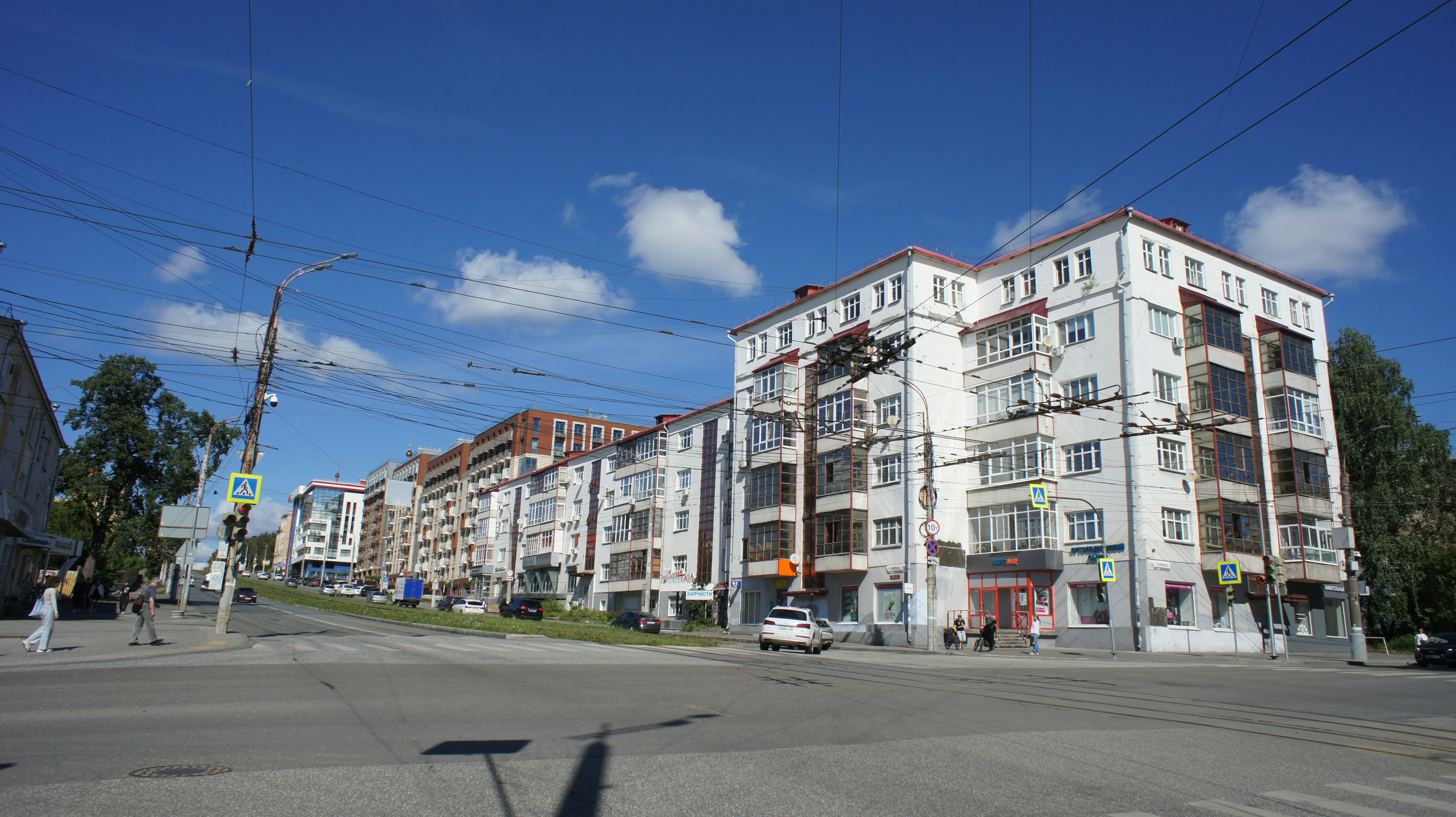Wide Boulevard: A Sunlit Street life Framed by Stately White Apartments