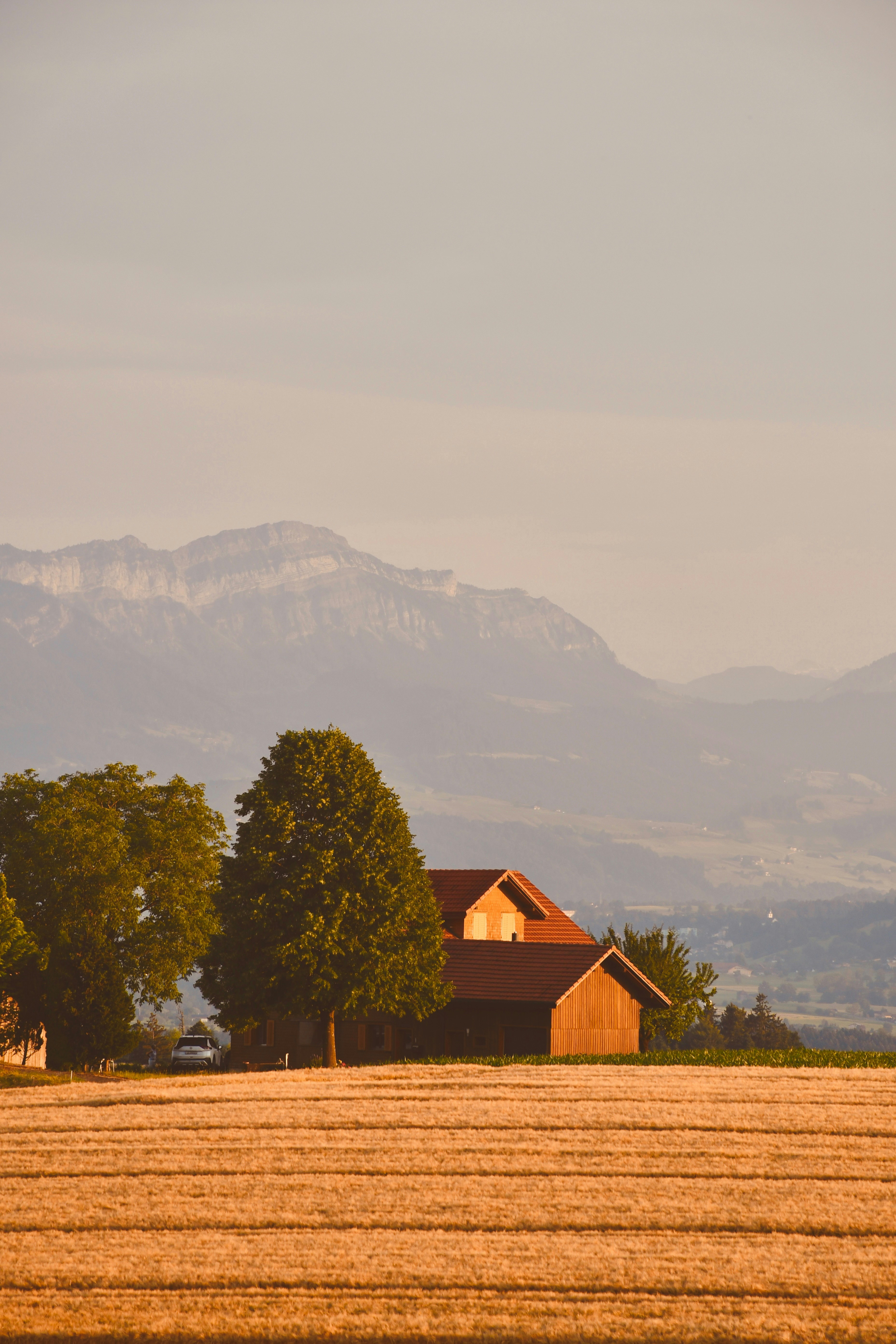 Warm Farmstead Beneath Distant Peaks