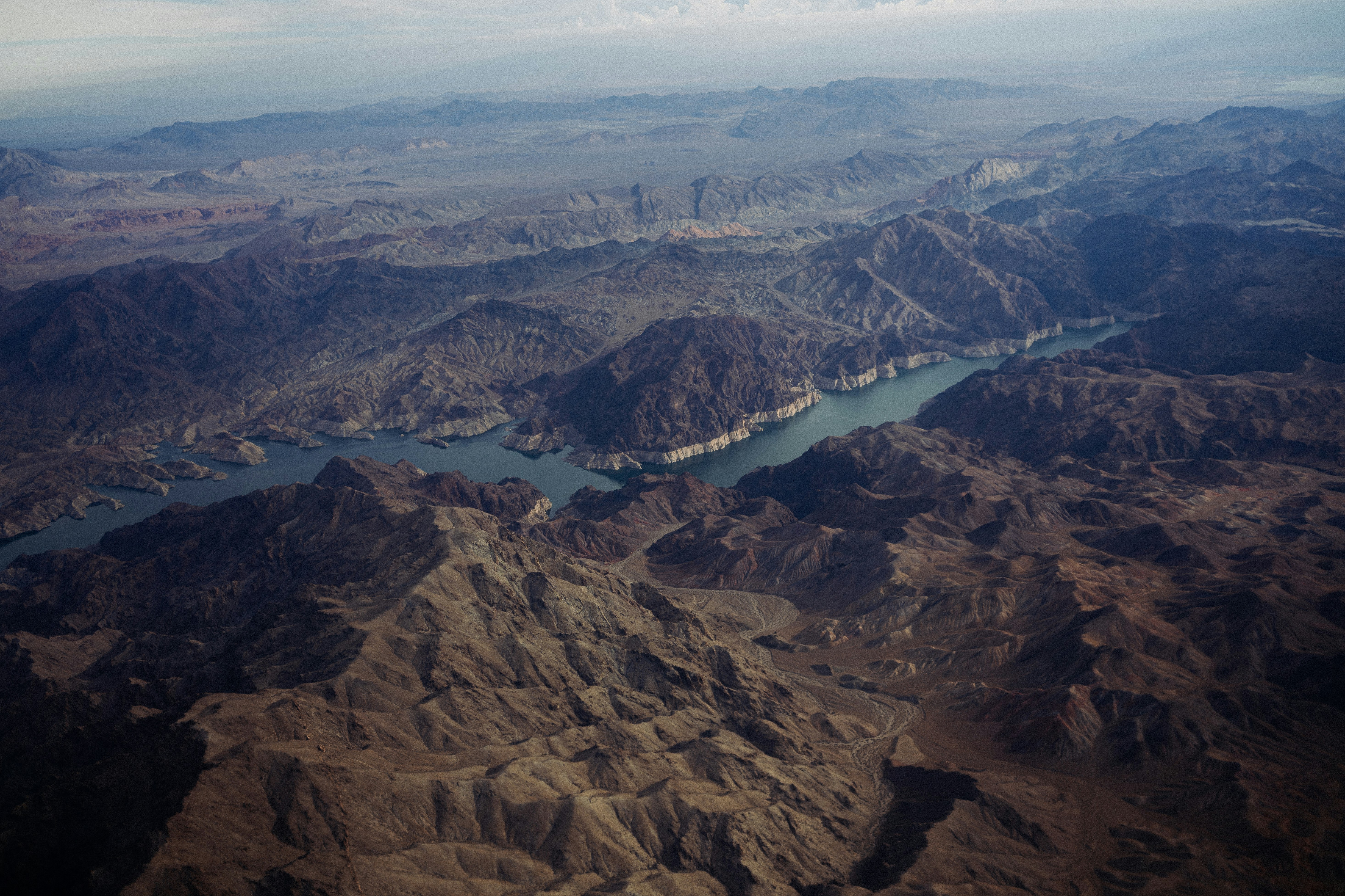 Aerial Wraiths: A Canyon-Rim View Over Serpentine Reservoirs