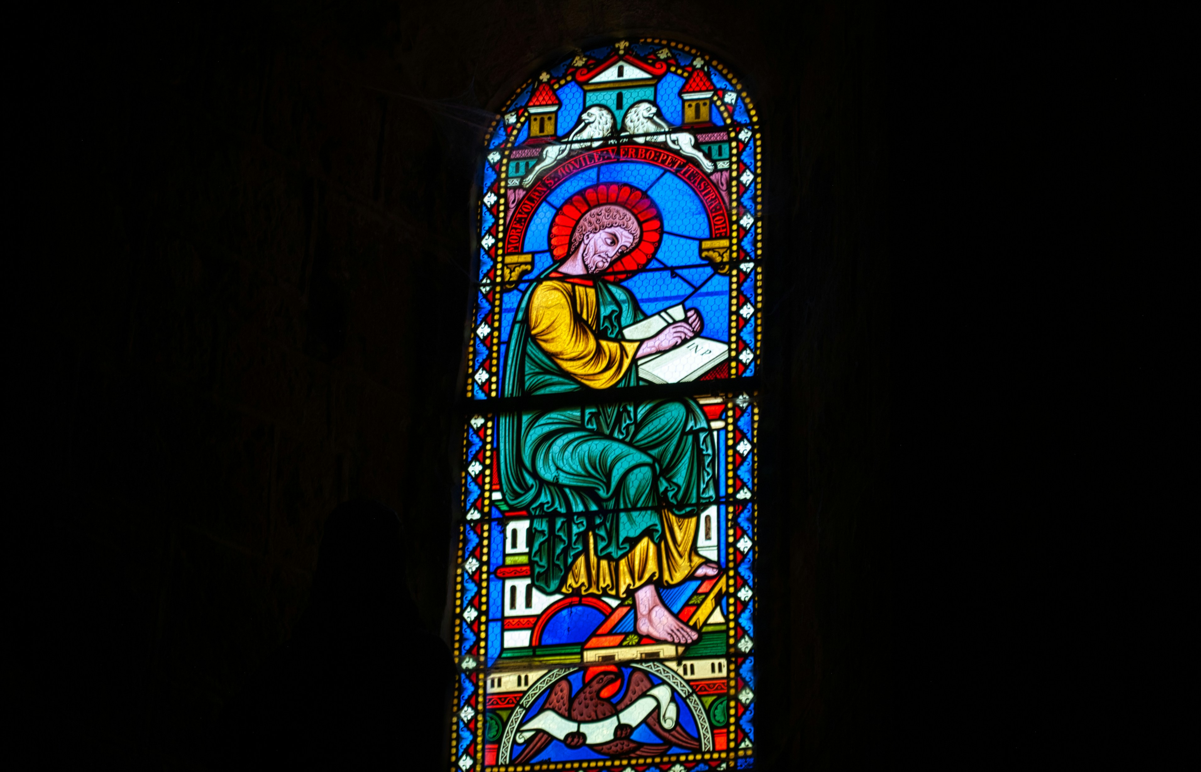 Saintly Scribe in Stained Light