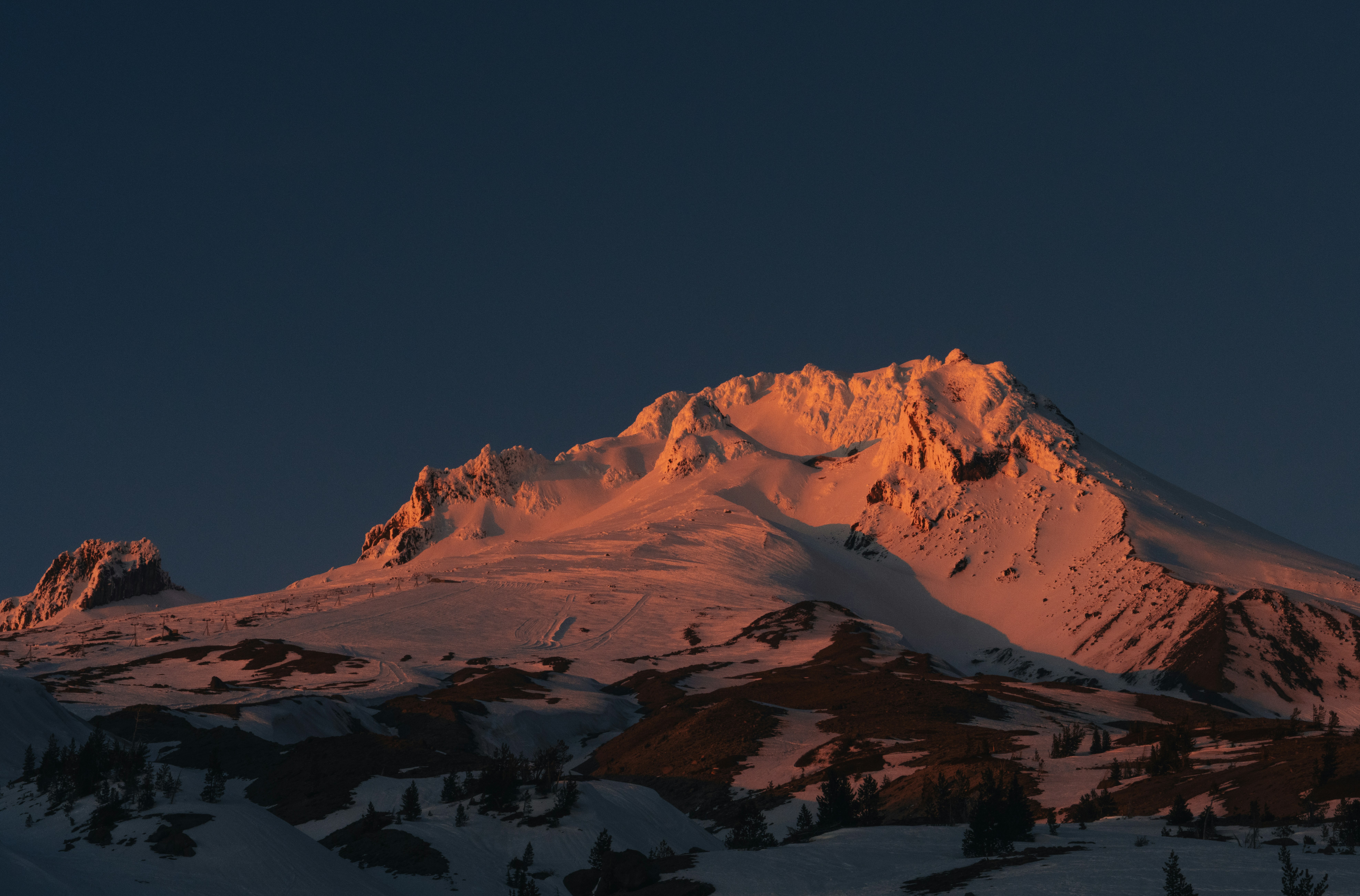 Alpenglow on the Summit: A Lone Peak Bleeding Warm Light