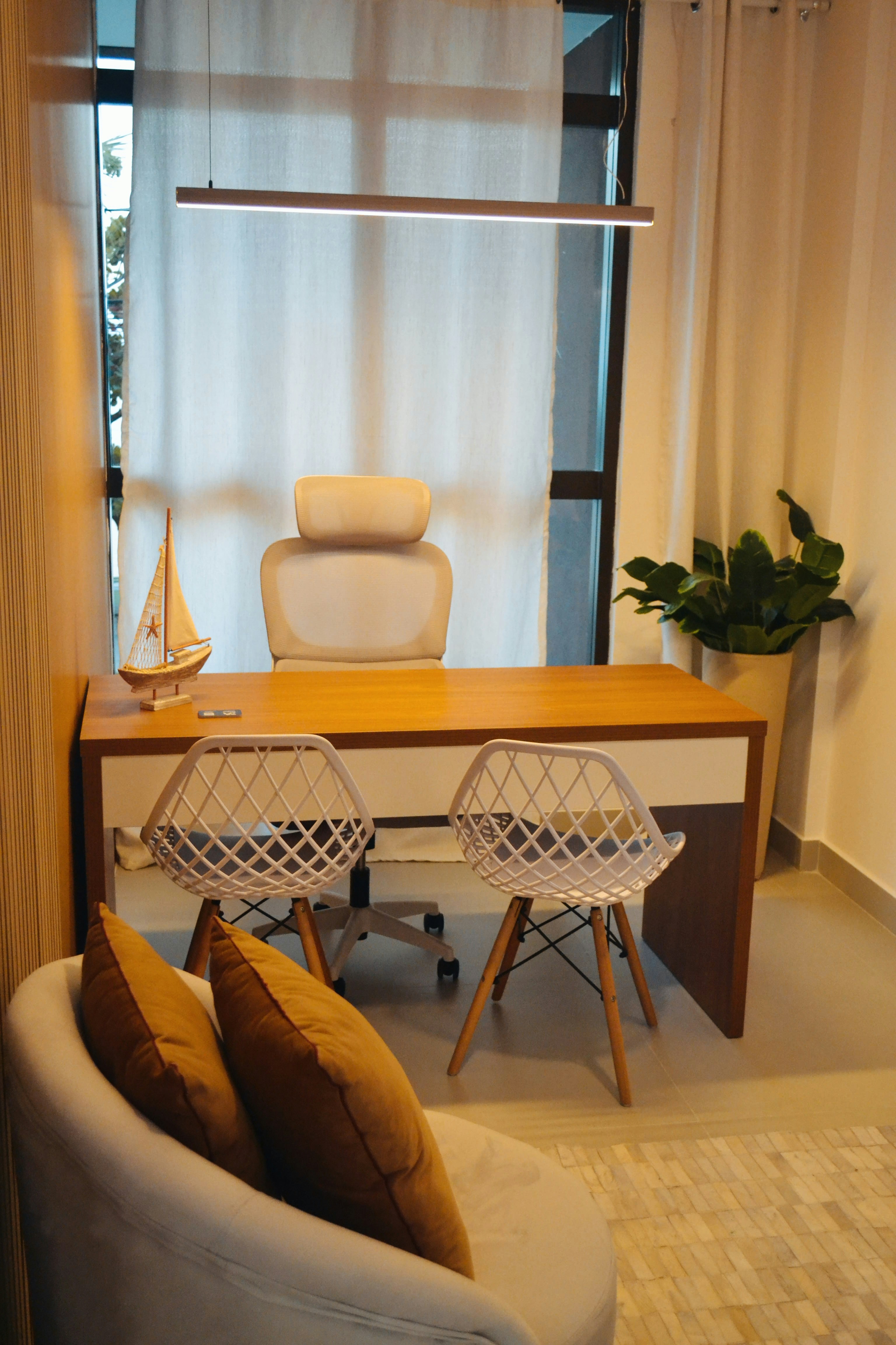Minimalist desk setup under soft daylight with a white executive chair