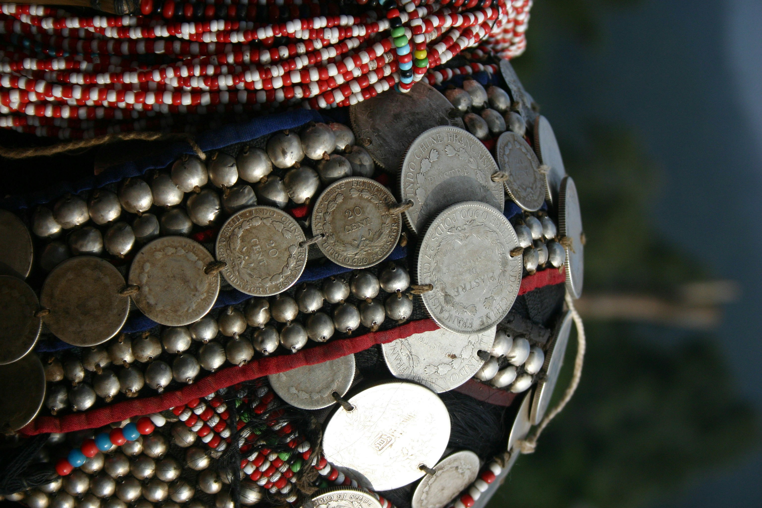 Beaded Carriage of Coins: A Tapestry of Metal Beads and Circles