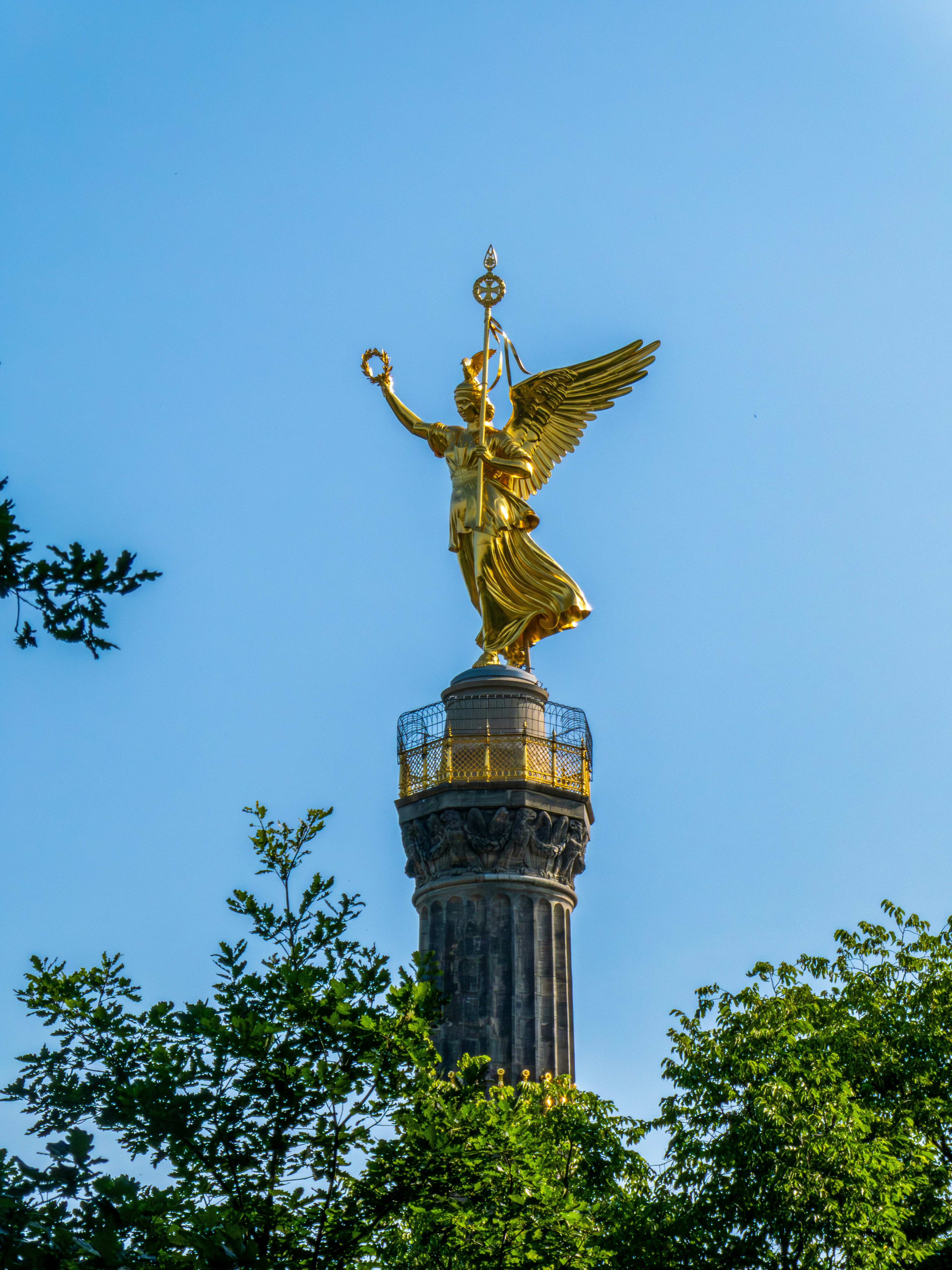 Golden Statue Crowned by a Clear Day Sky