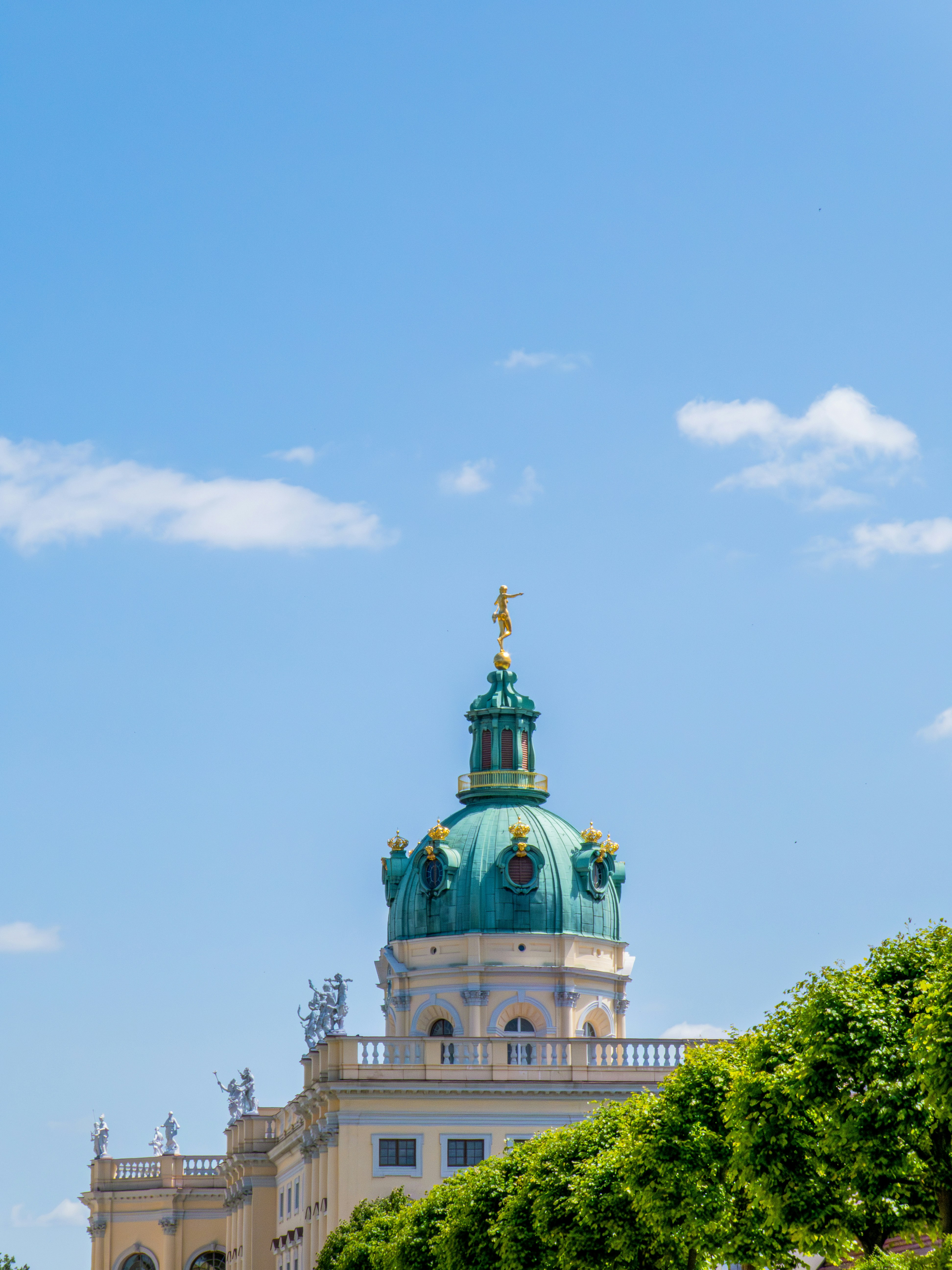 Crowned Dome under Clear Sky: Architectural Majesty Framed by Greenery