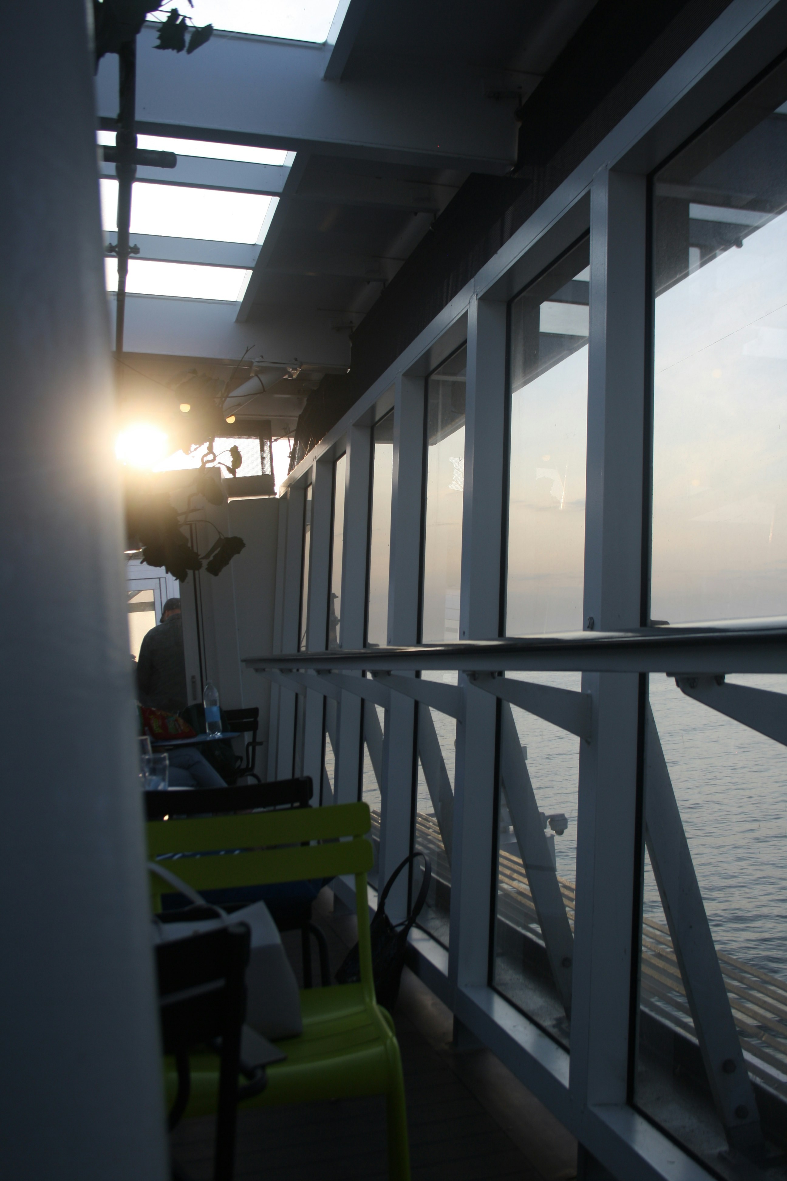 Horizon Light on the Glass: Sunset Portrait on a Vessel Balustrade