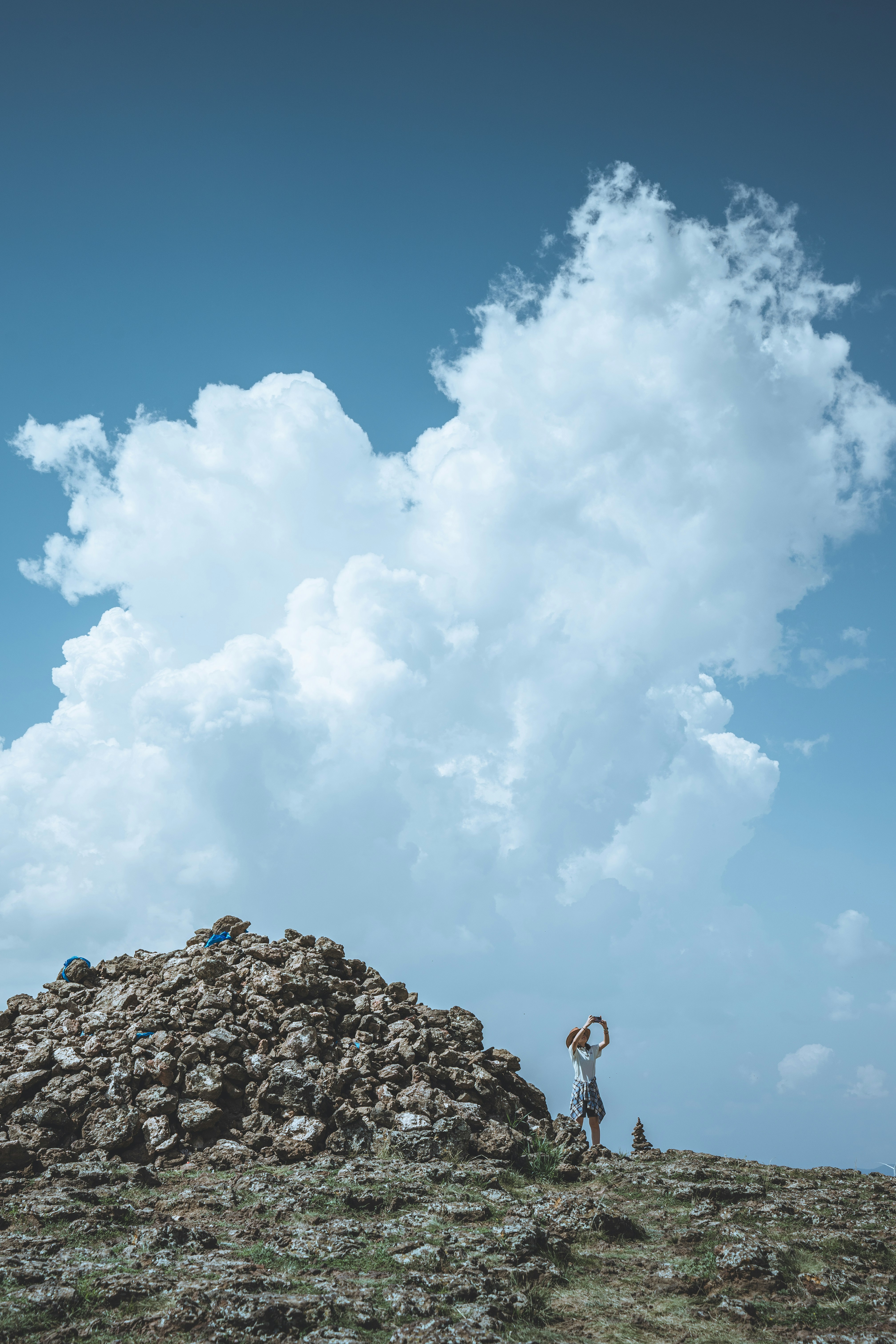 Cloud Peak: A Lone Hiker Reaches Skyward Beneath a Painted Sky