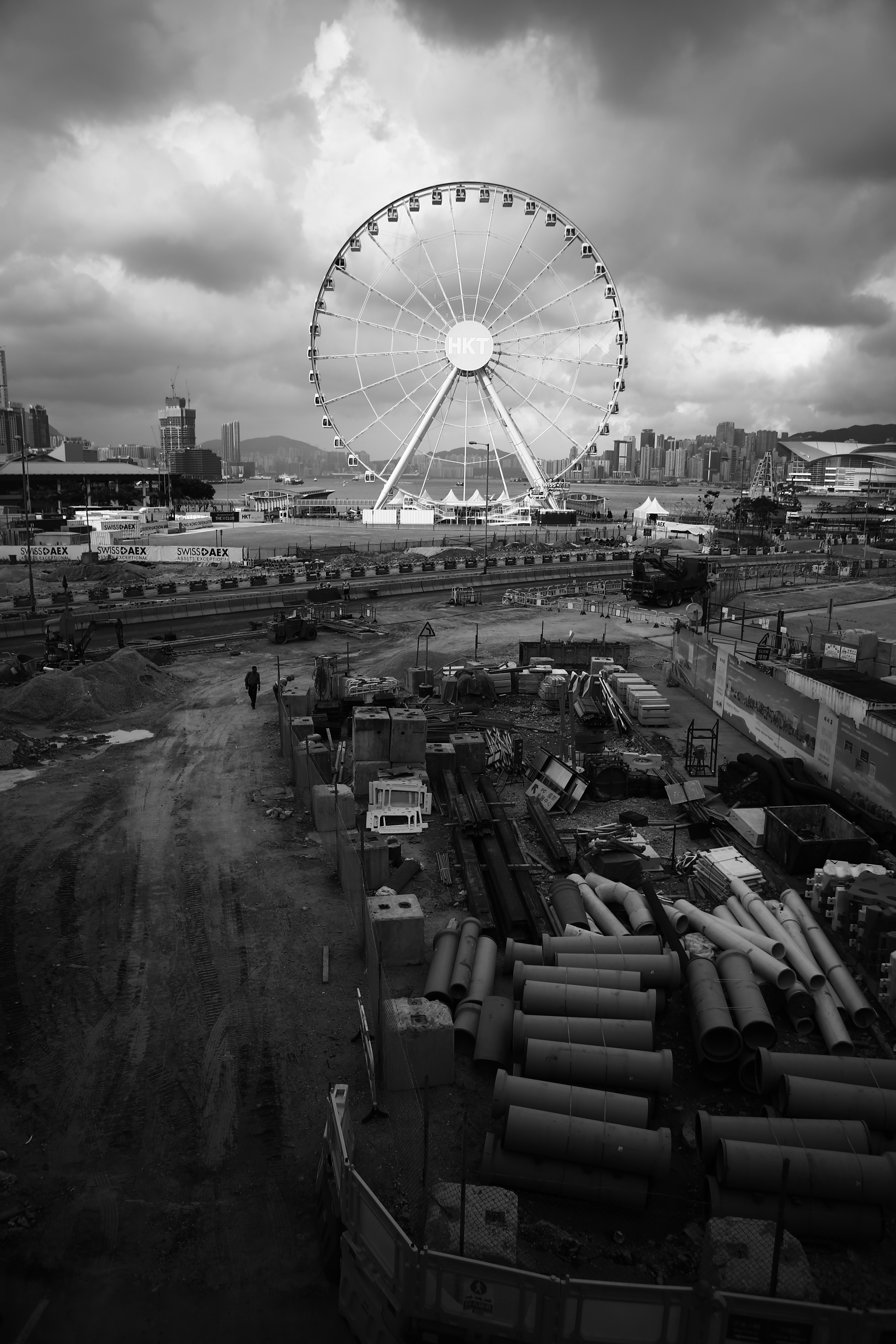 Industrial foreground, bright ferris wheel: a northern cityscape under cloudy skies