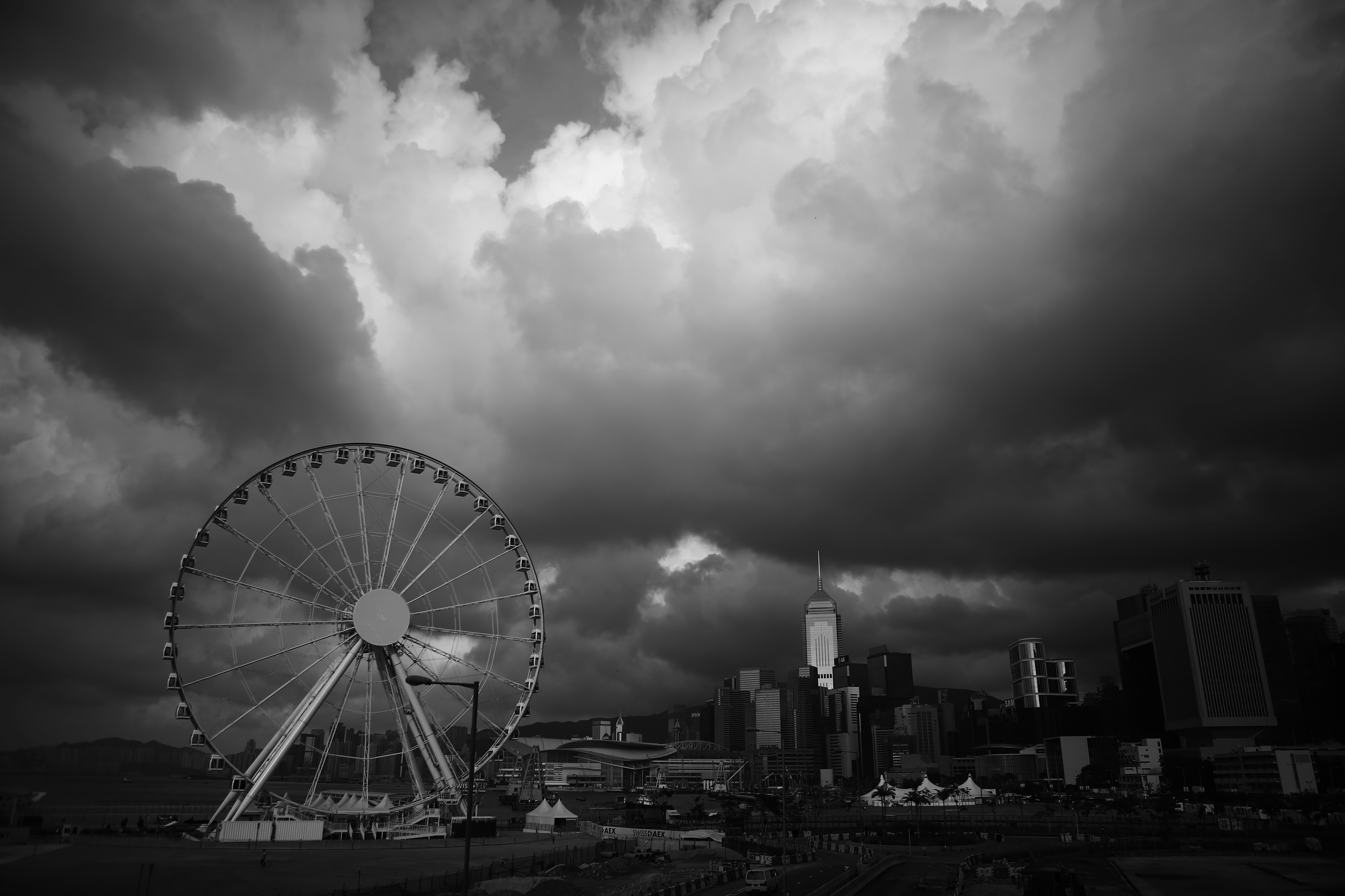 Edge of the Sky: Ferris Wheel and City in Storm