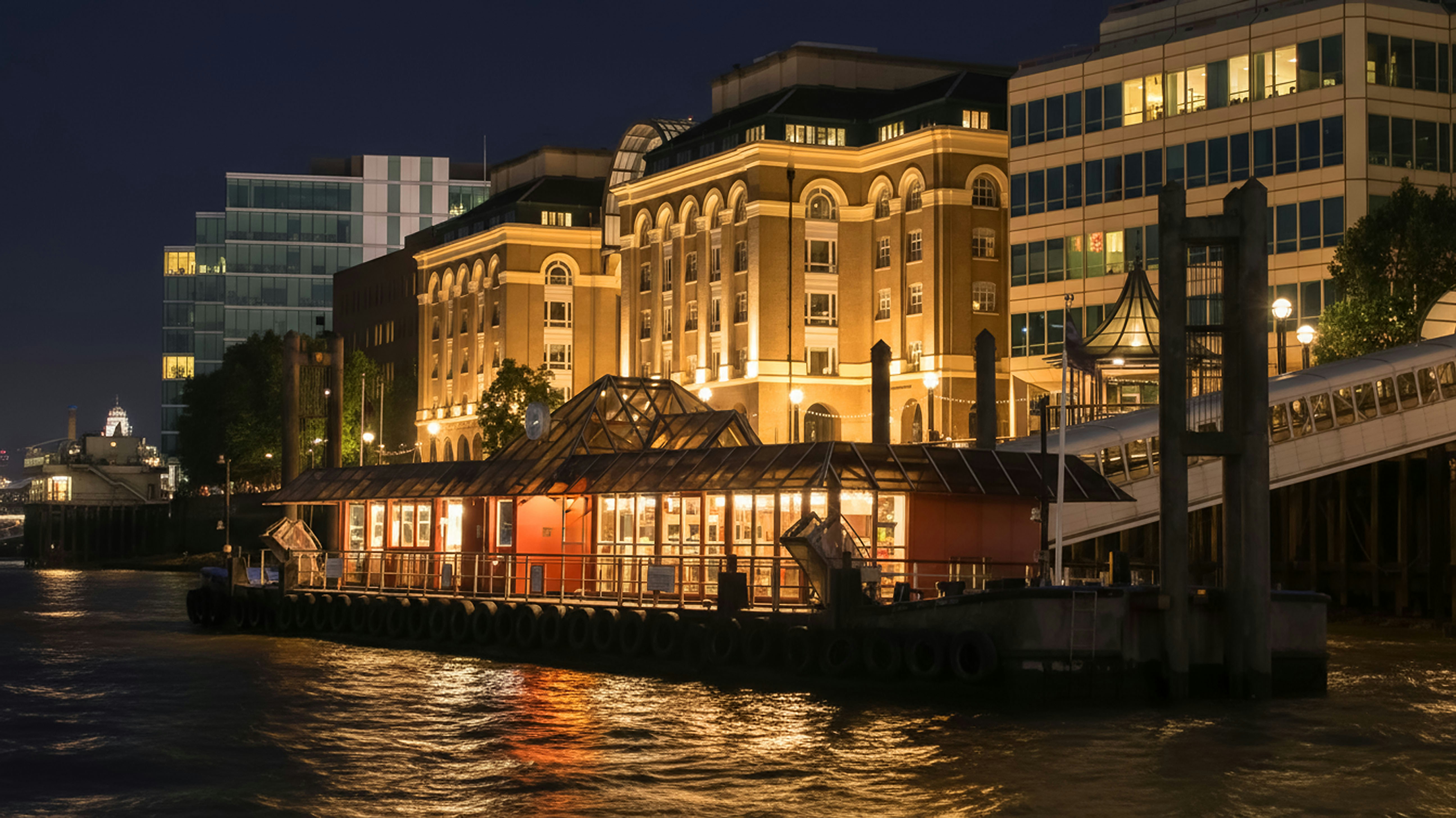 Night-Time Riverfront: Warm Lights Reflecting on a Modern Wharf