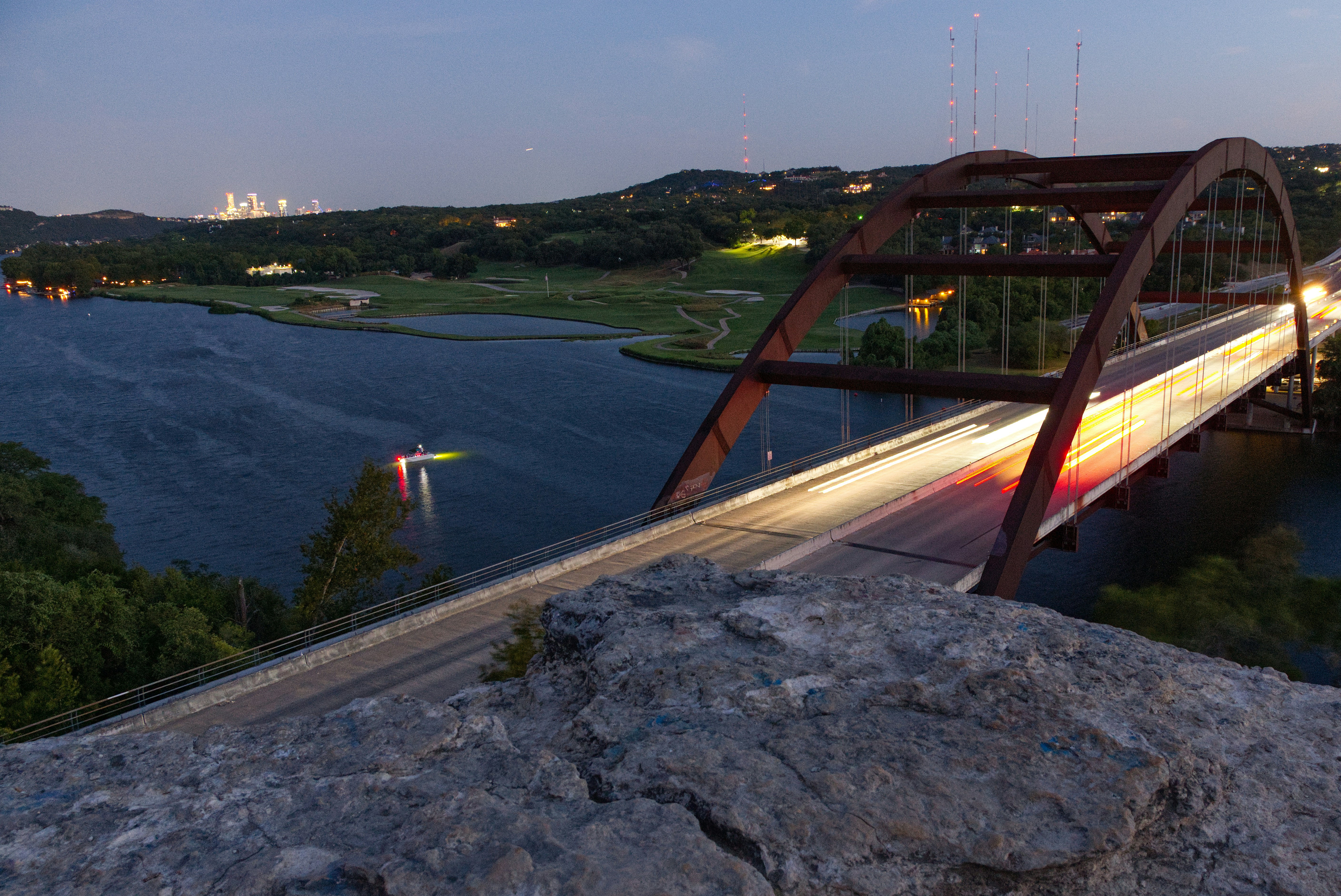 Light Trails Across a River-Span: Evening Traffic on a Modern Arch Bridge