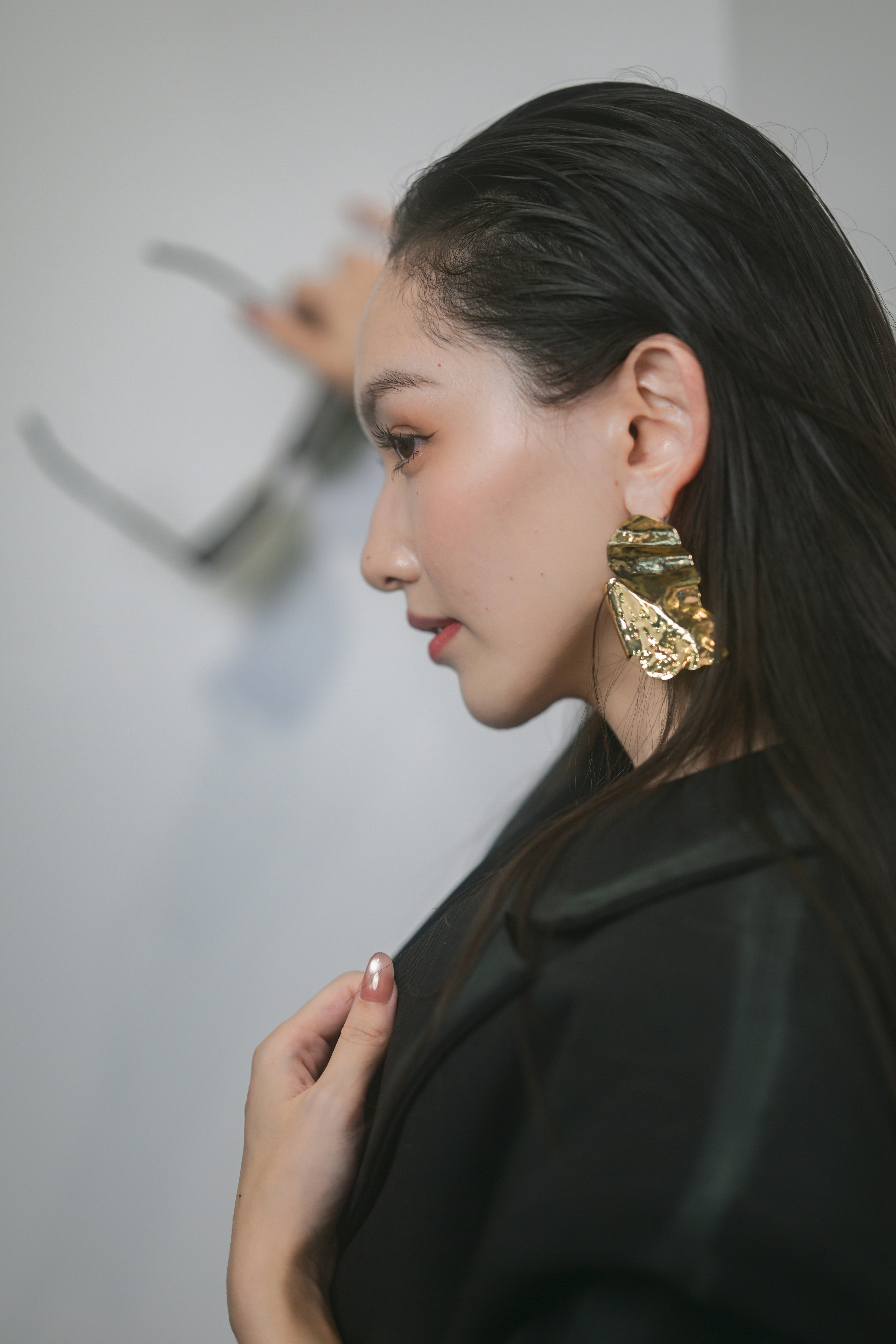 Profile in Gold: A Fashion Portrait with Soft Backdrop