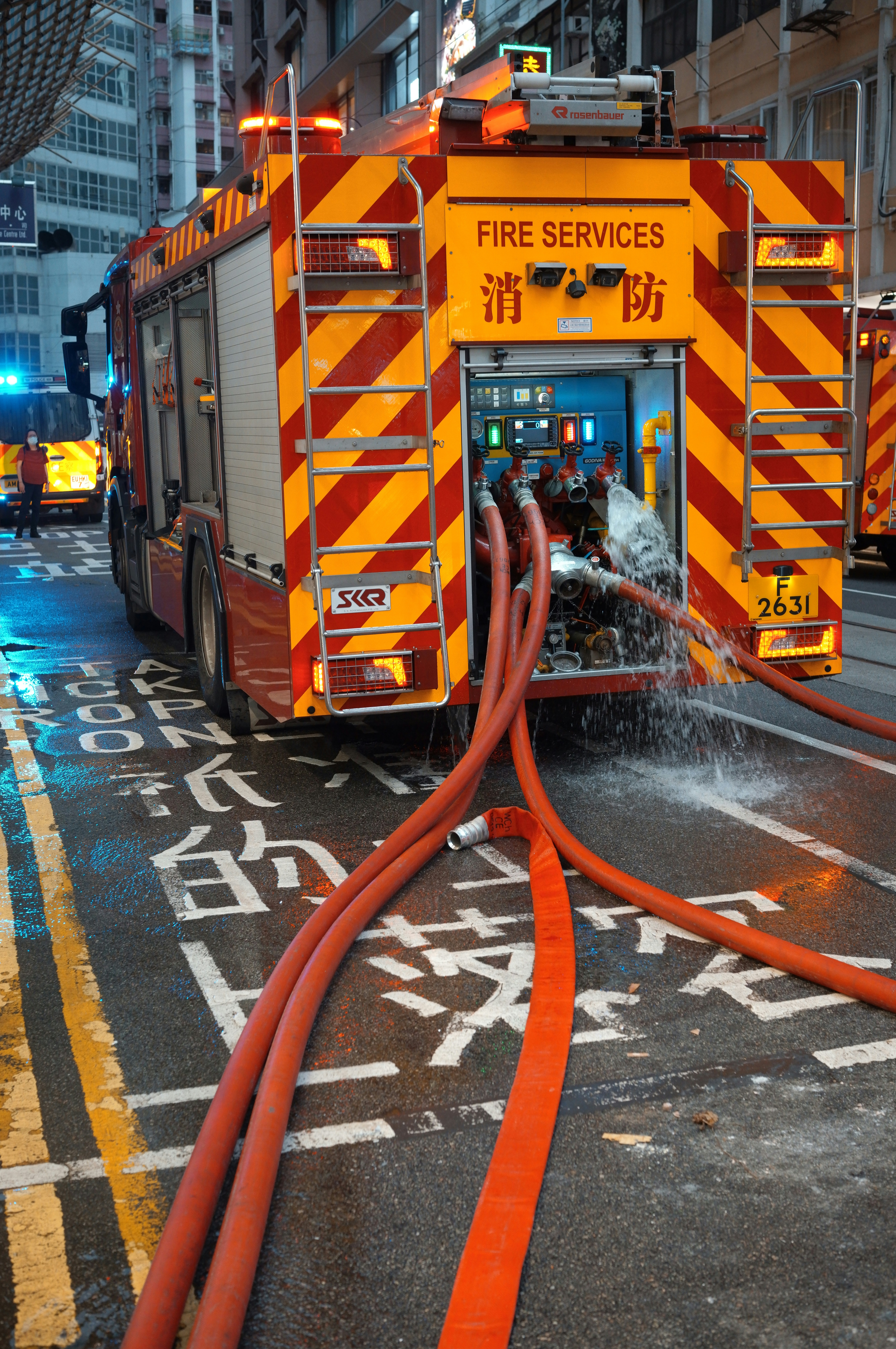 Rearward Flow: Red Fire Engine Hoses Unspooling in a Neon City