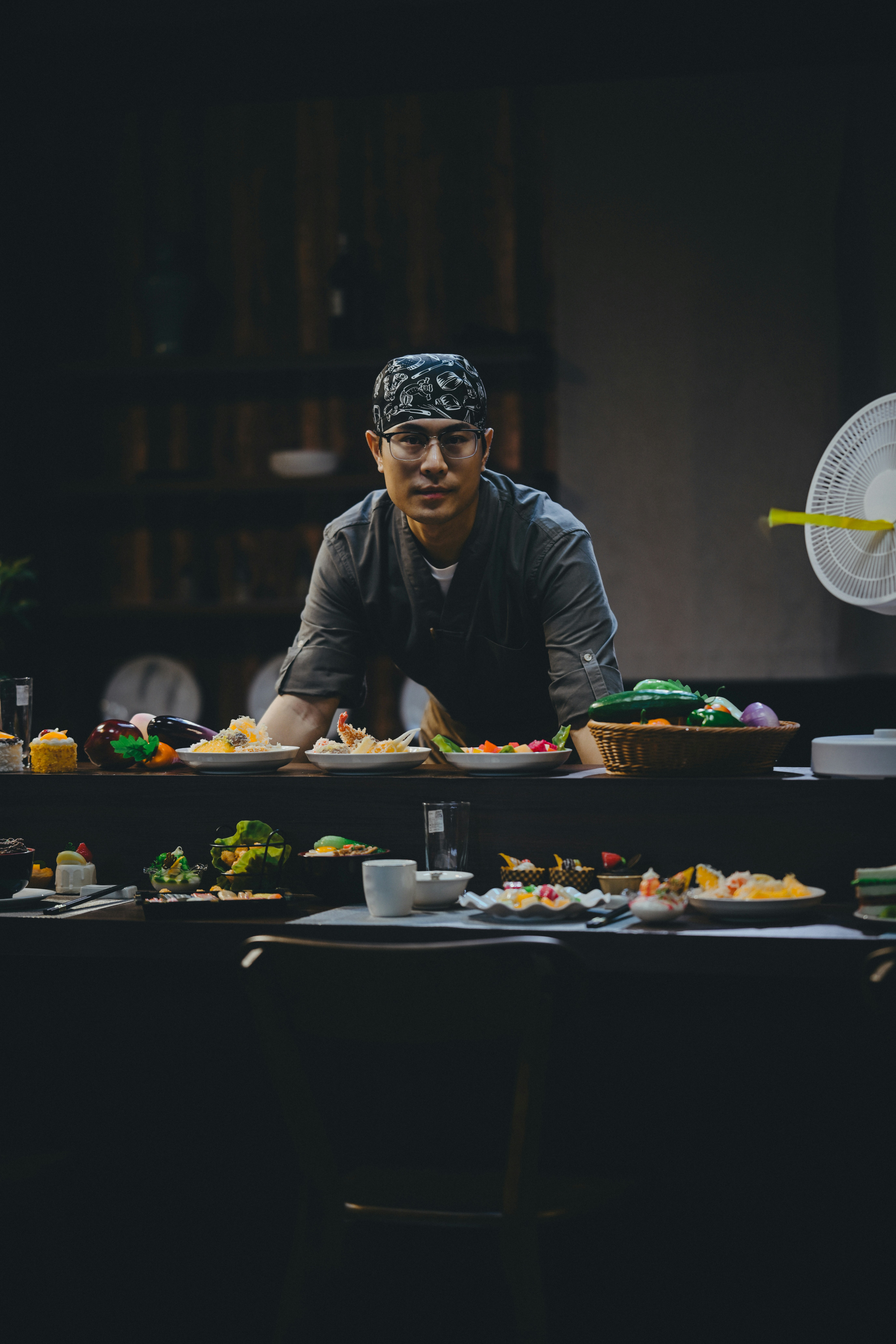 Chef at the Central Feast: A Focused Portrait in a Busy Kitchen