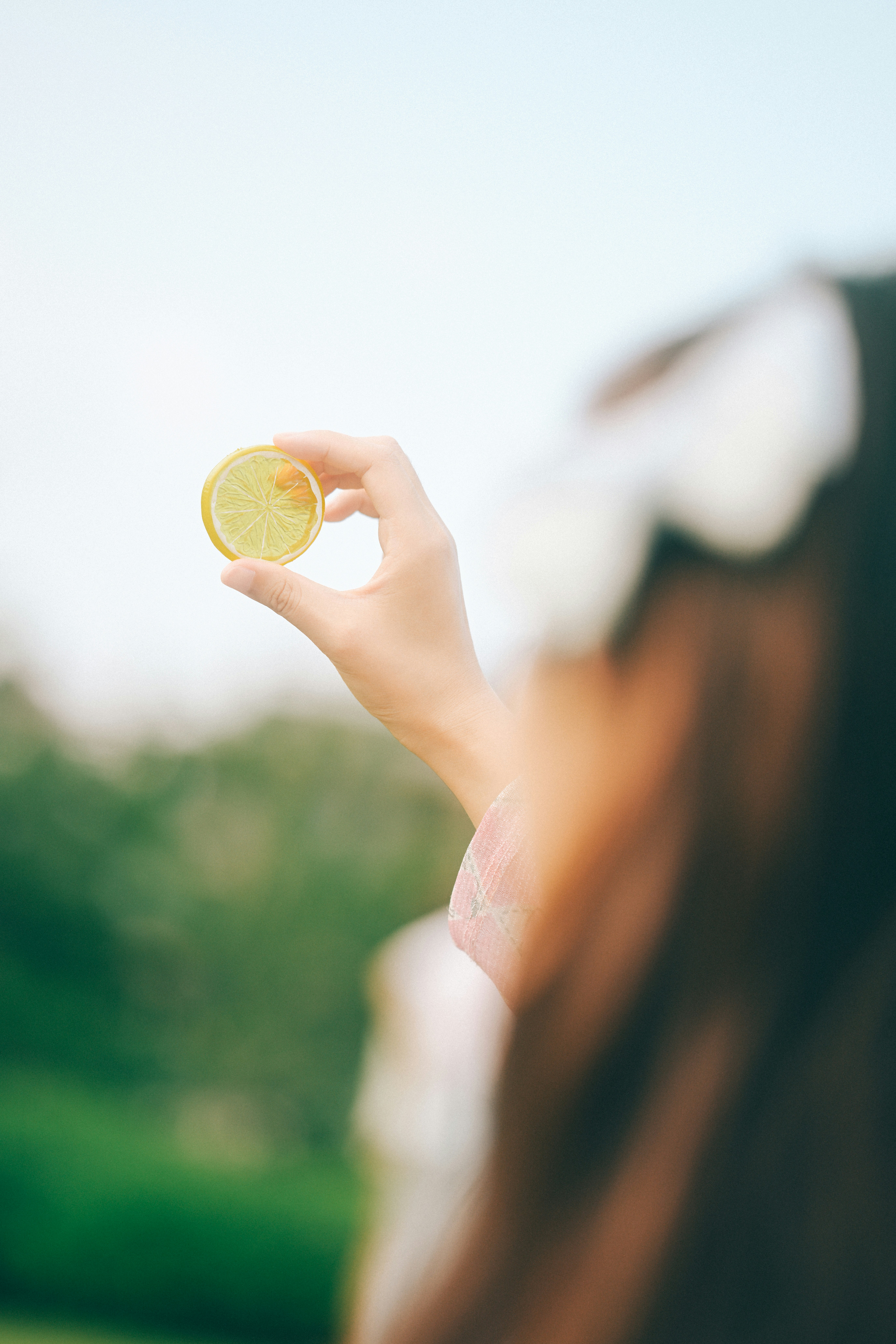Lemon Pinch: Hand-held Citrus Echo in Soft Sunlight