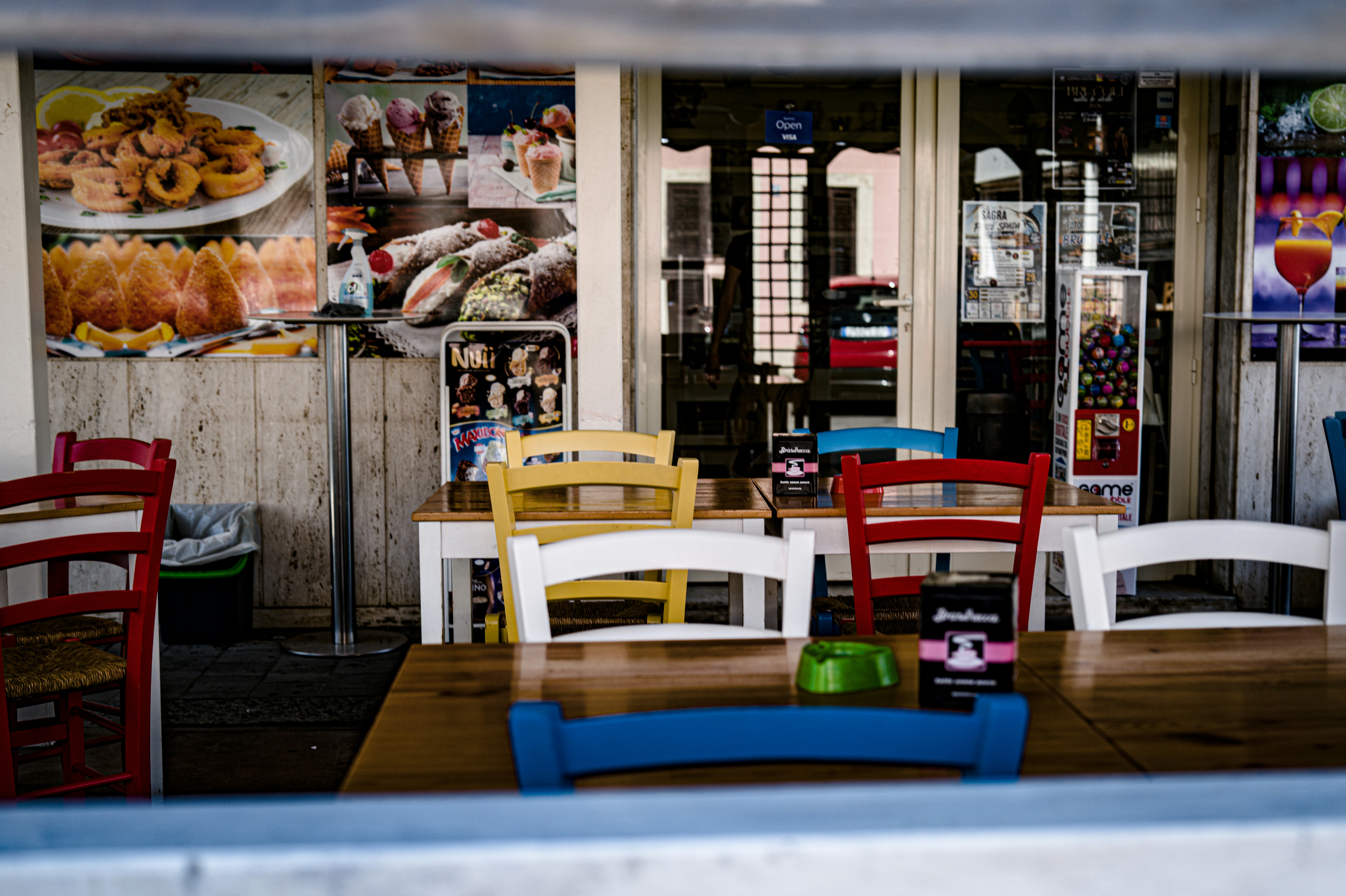 Colorful Café Resonance: Chairs, Light, and a Quiet Street Through the Window