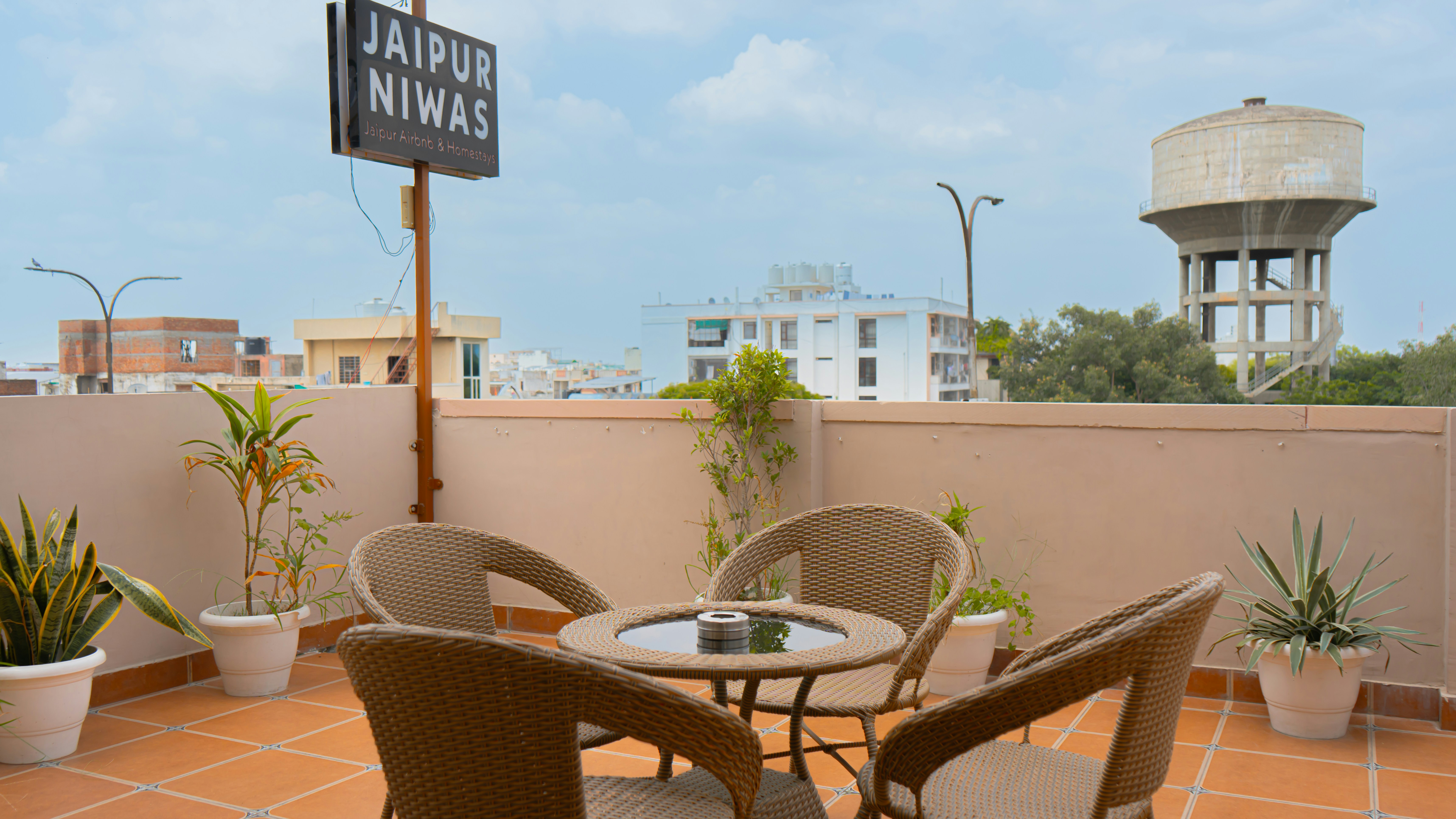 Rooftop Lounge with Distant Cityscape and Water Tower