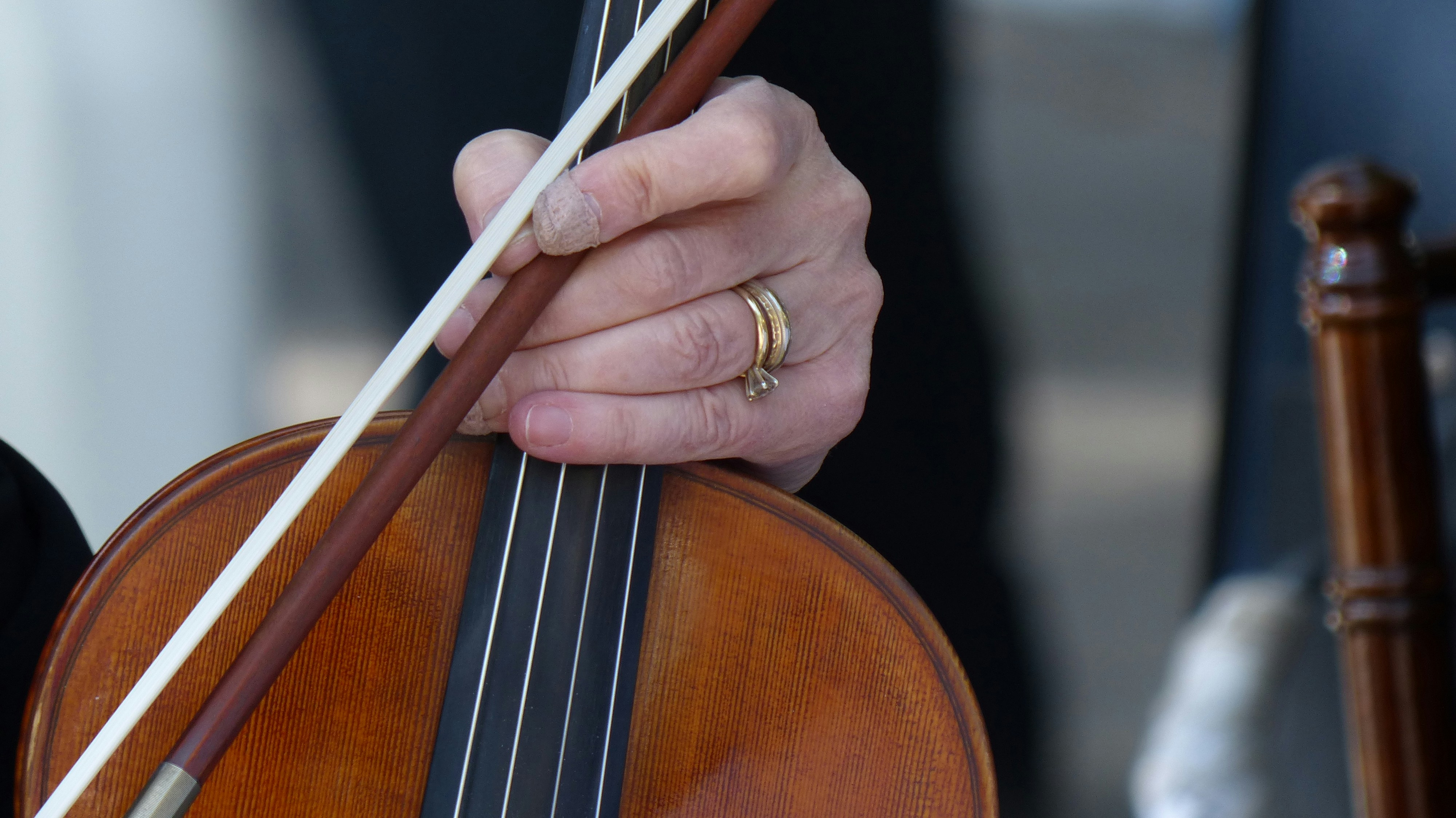 A bowed violin and careful hands: delicate craft in focus