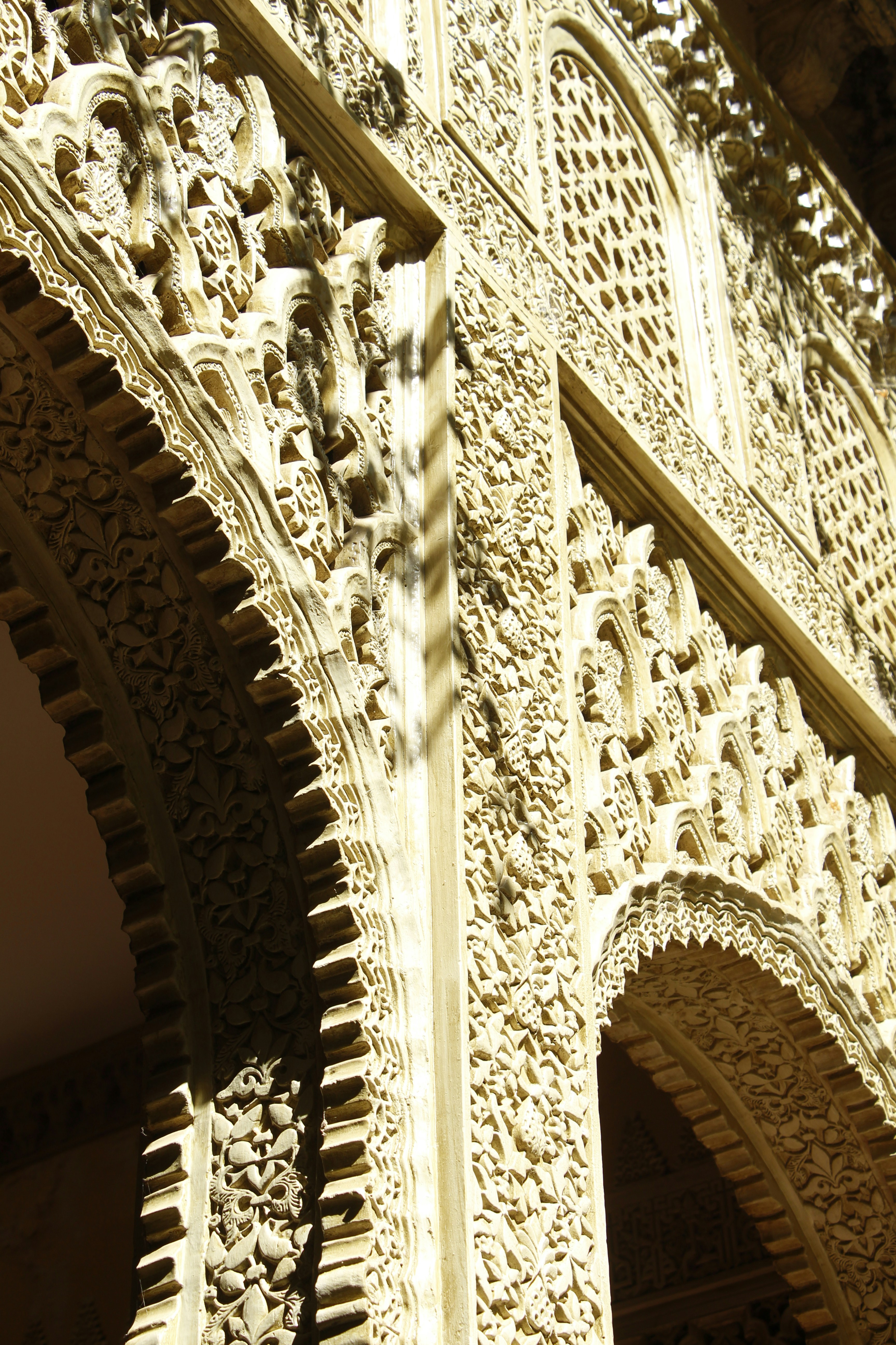 Archway in Sunlit Carved Facade Revealing OrnateStone Work