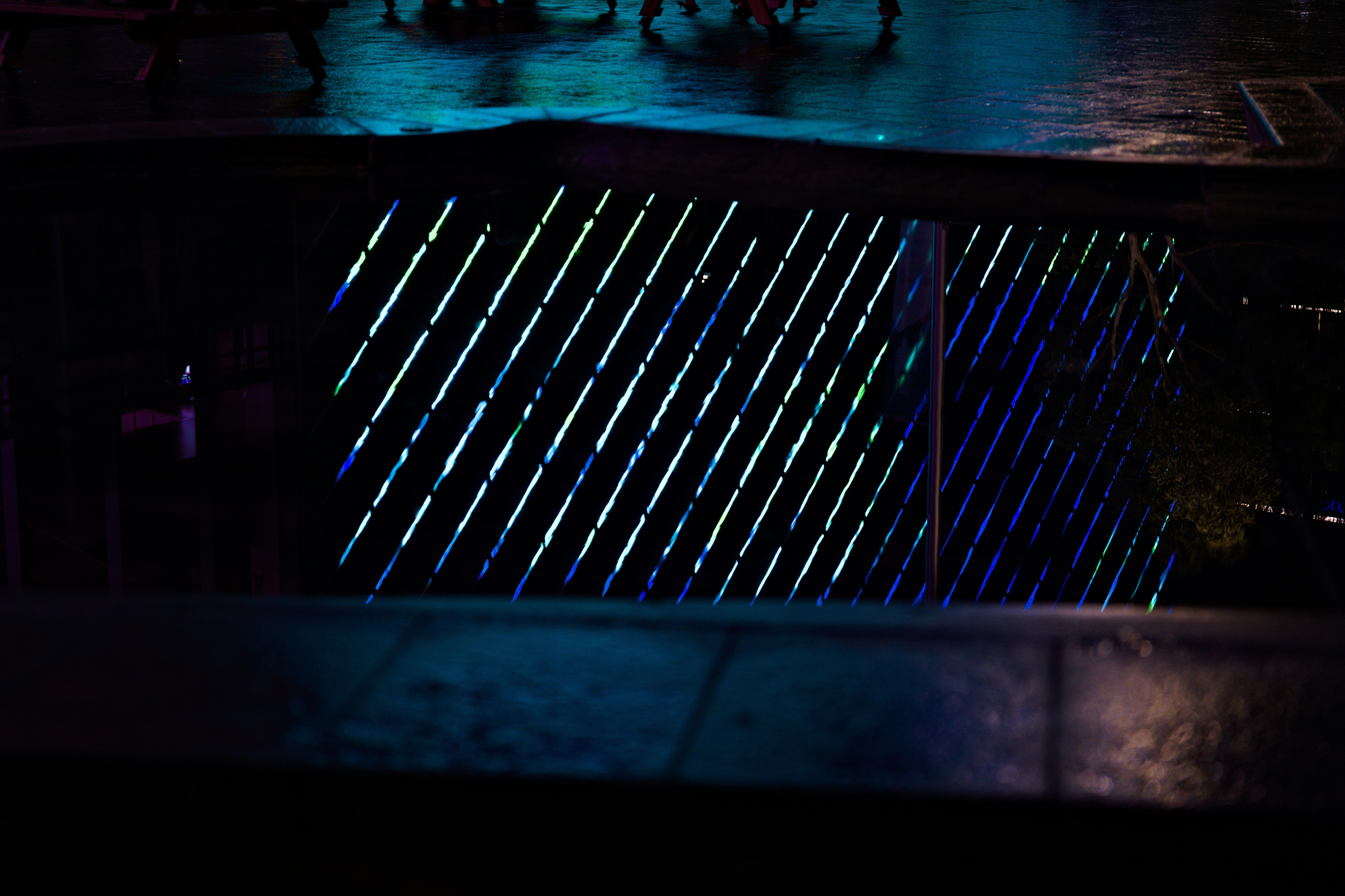 Neon Slices Across a Quiet Night Pool