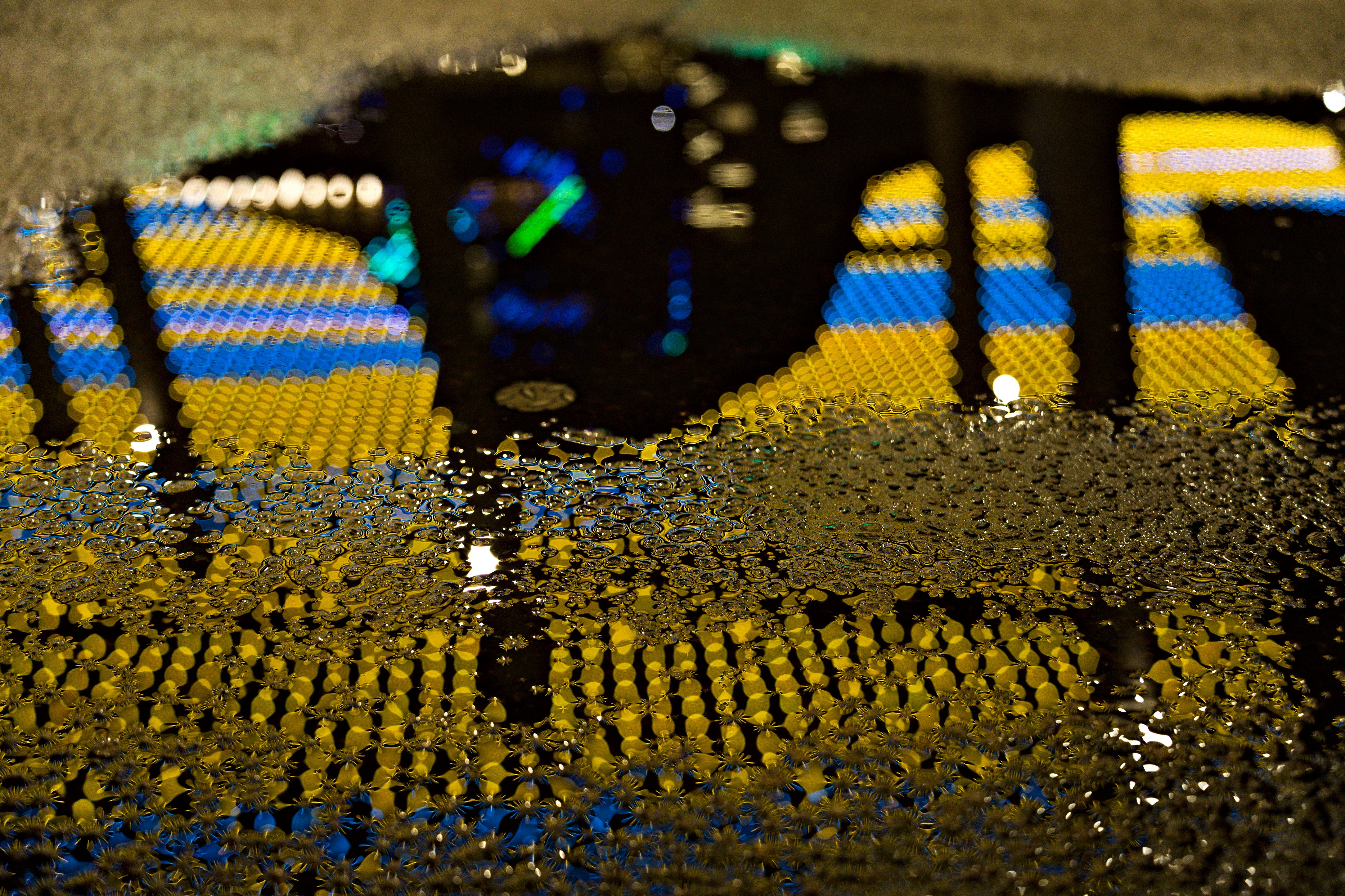 Neon Reflections in a Wet Industrial Corridor